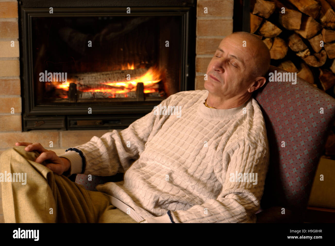 Man sleeping by fireplace hi-res stock photography and images - Alamy