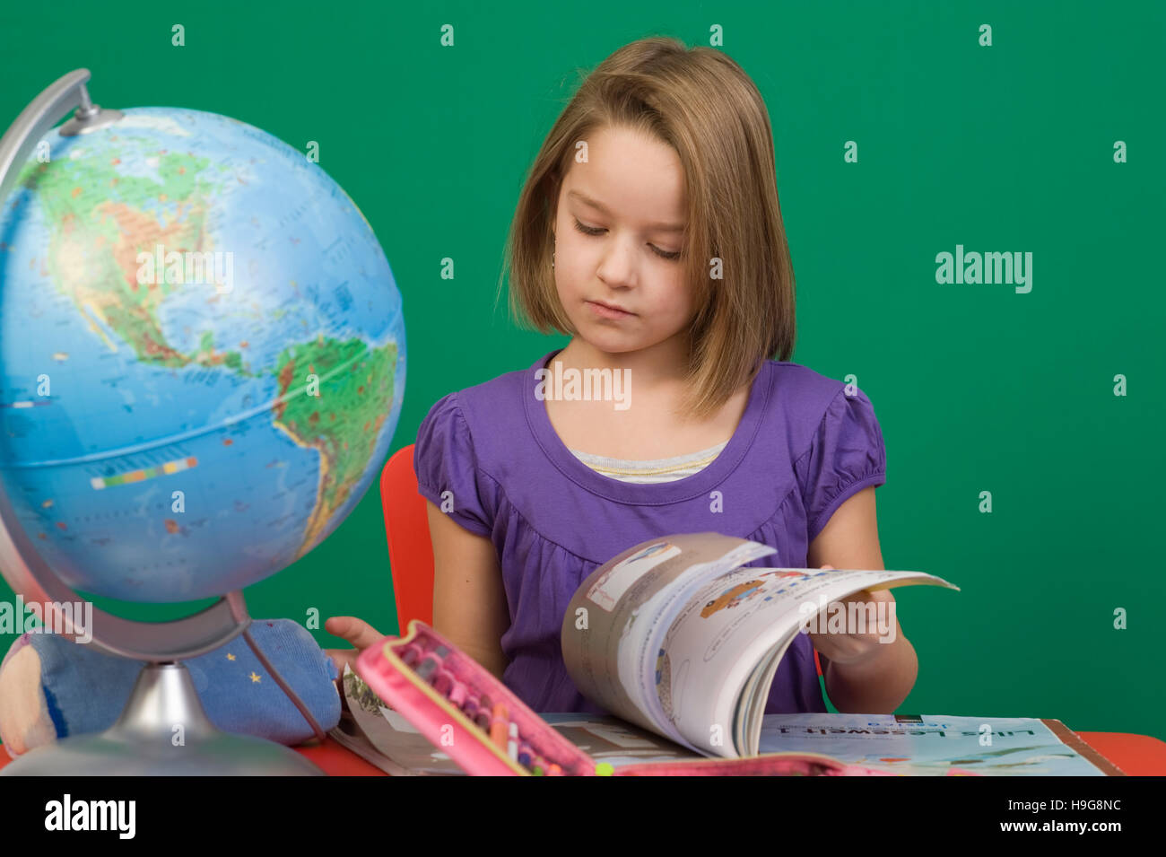 School girl with learning sheets Stock Photo - Alamy