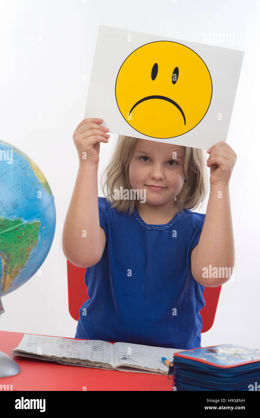 Girl at her desk, sad smiley, symbolic picture for problems in school ...