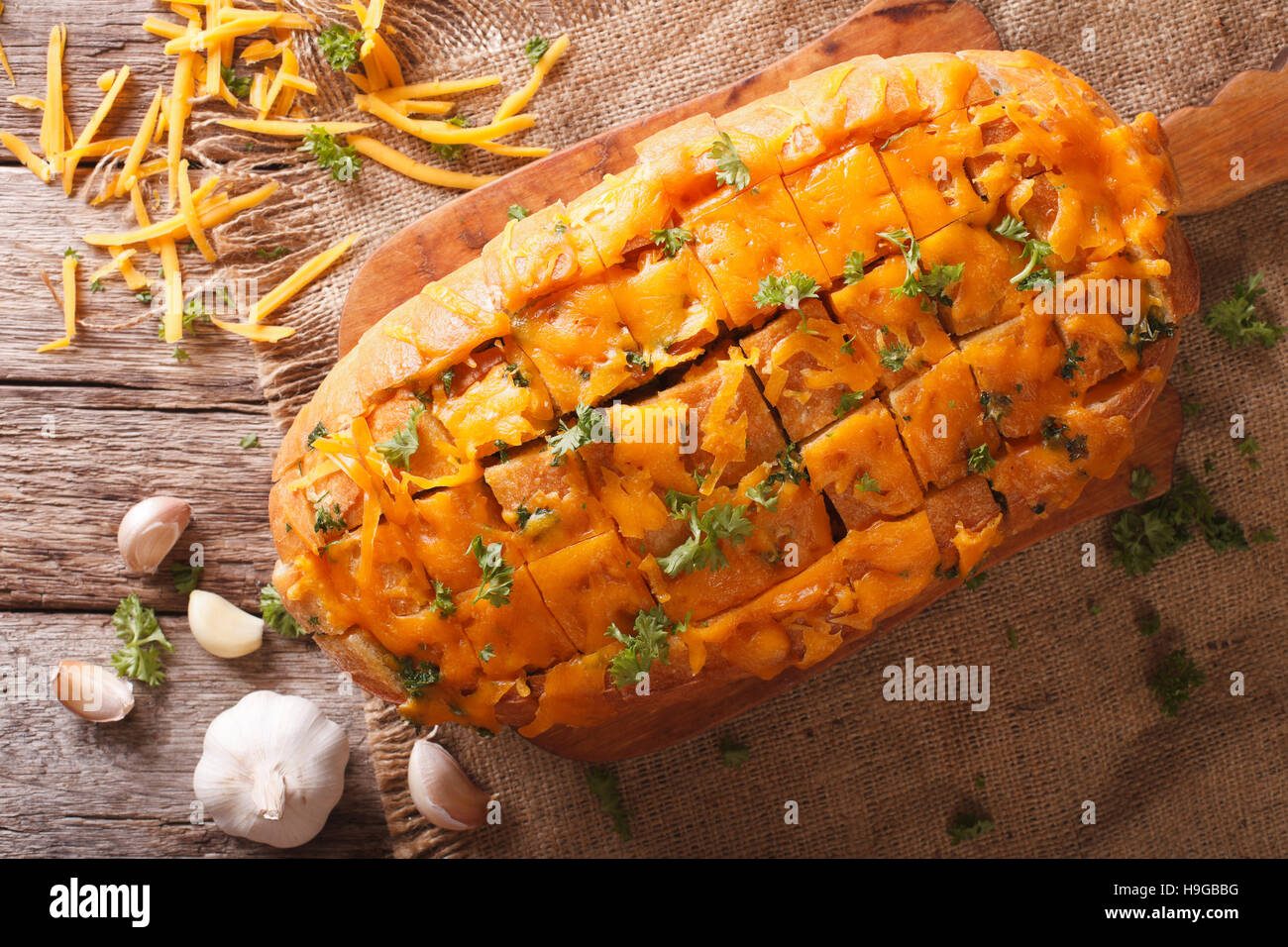 Bread with cheddar cheese, garlic and herbs closeup on the table ...