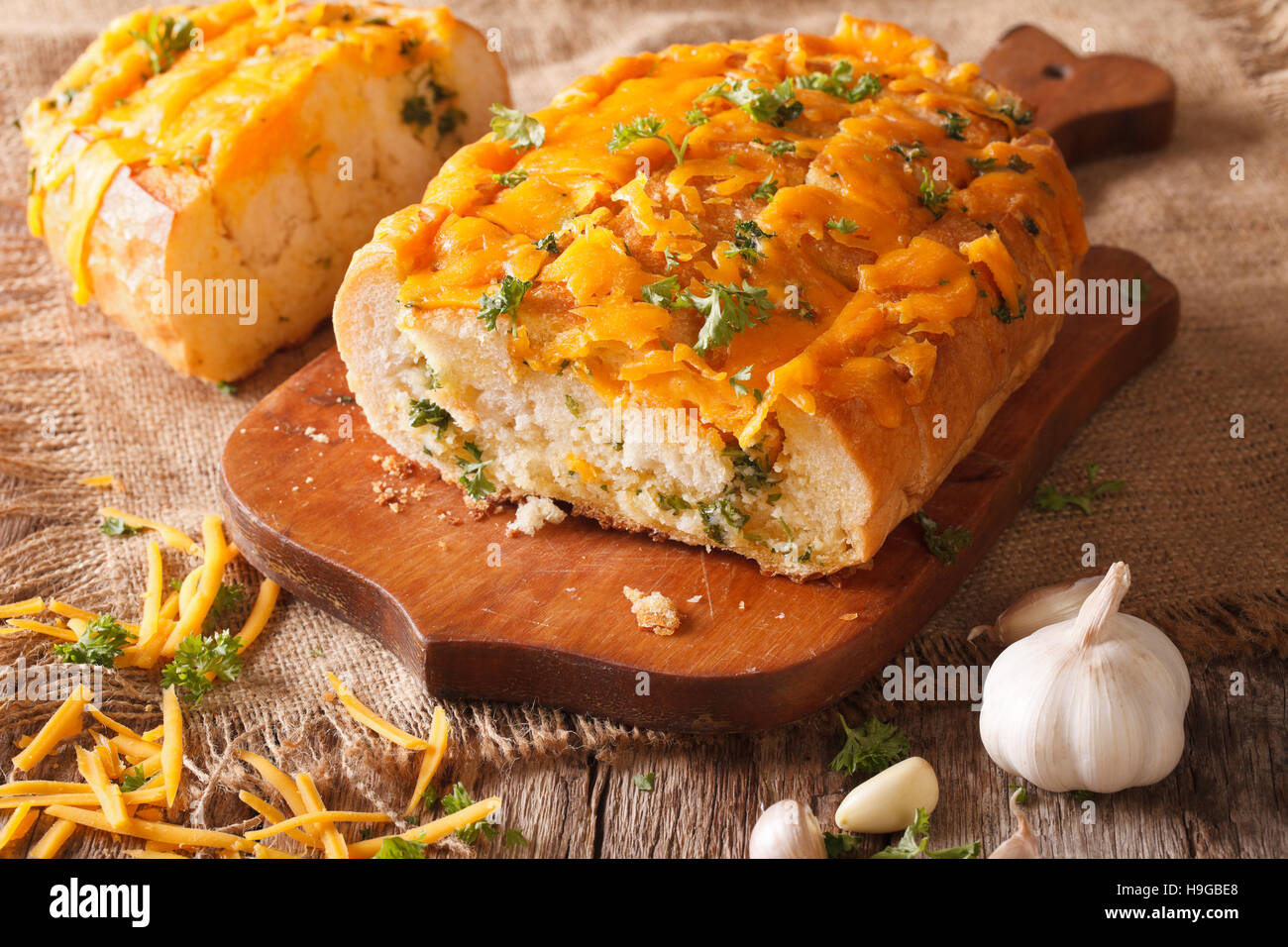 Cheddar bread with garlic and herbs closeup on the table. horizontal ...