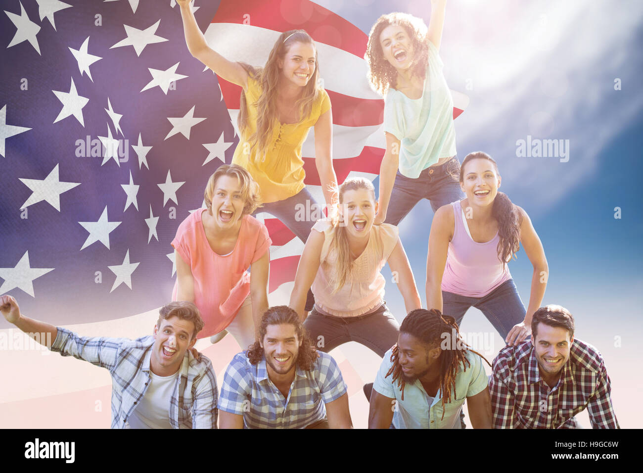 Composite image of happy friends in the park making human pyramid Stock ...