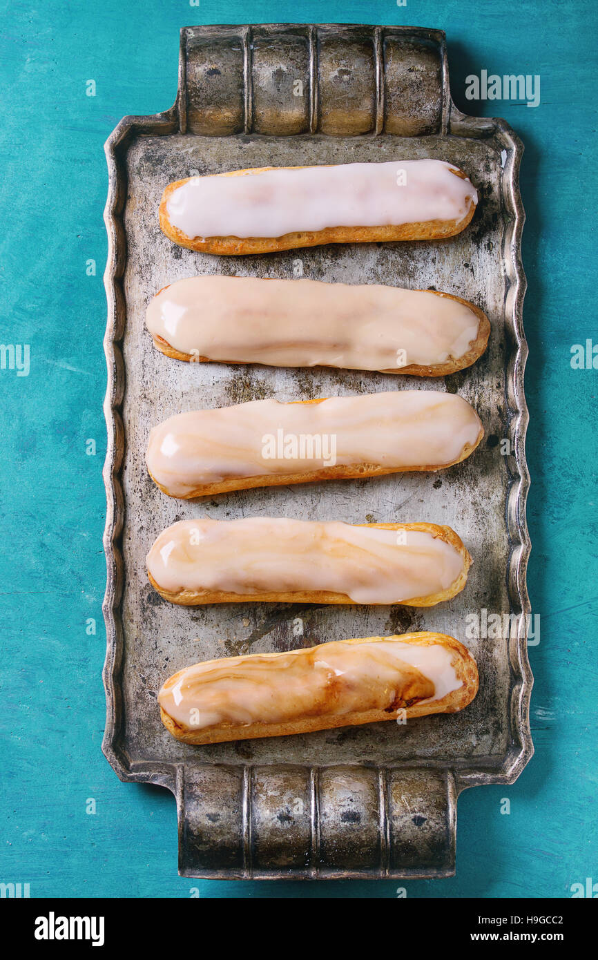 Coffee eclairs on vintage tray Stock Photo - Alamy