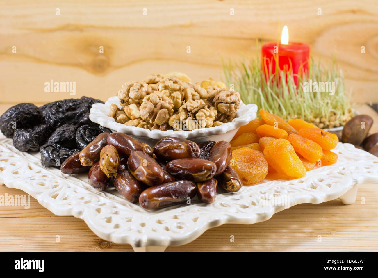 Fried fruit served as Christmas Eve offerings with a candle Stock Photo ...