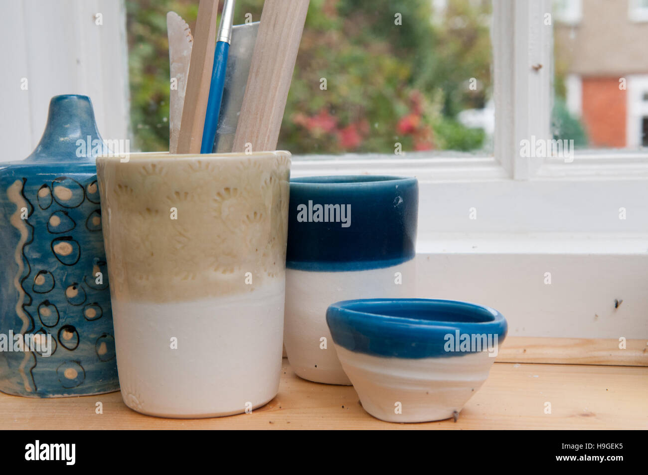 Pottery tools and vases on a window ledge in daylight Stock Photo - Alamy