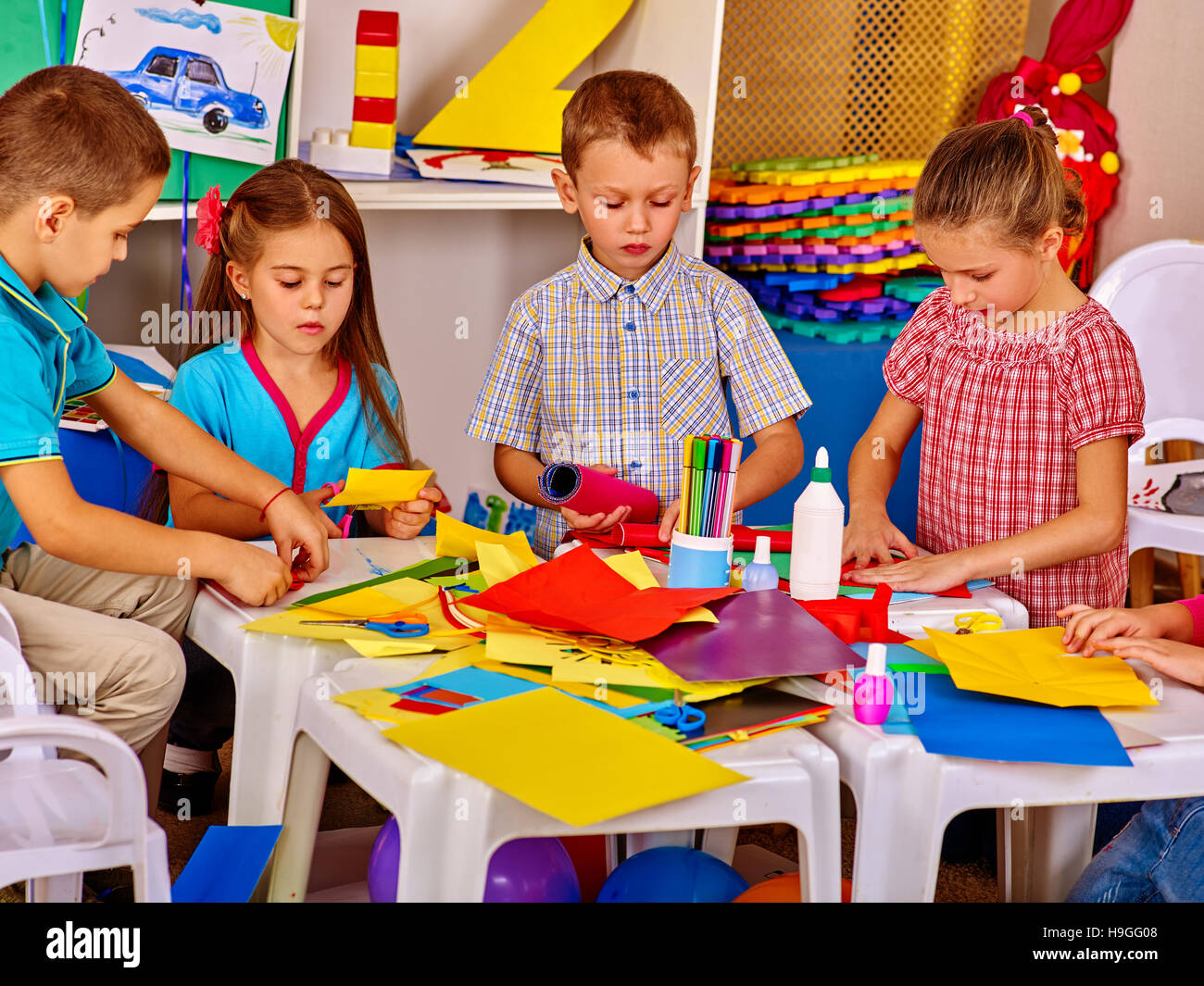 Children are making something out of colored paper Stock Photo - Alamy