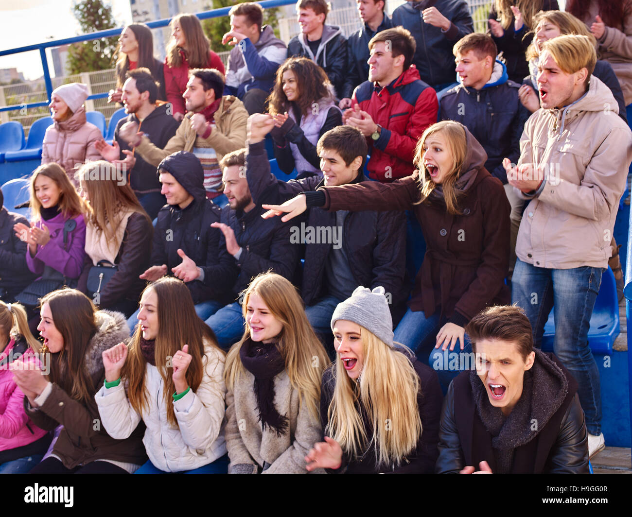 Sport fans clapping and singing on tribunes Stock Photo - Alamy