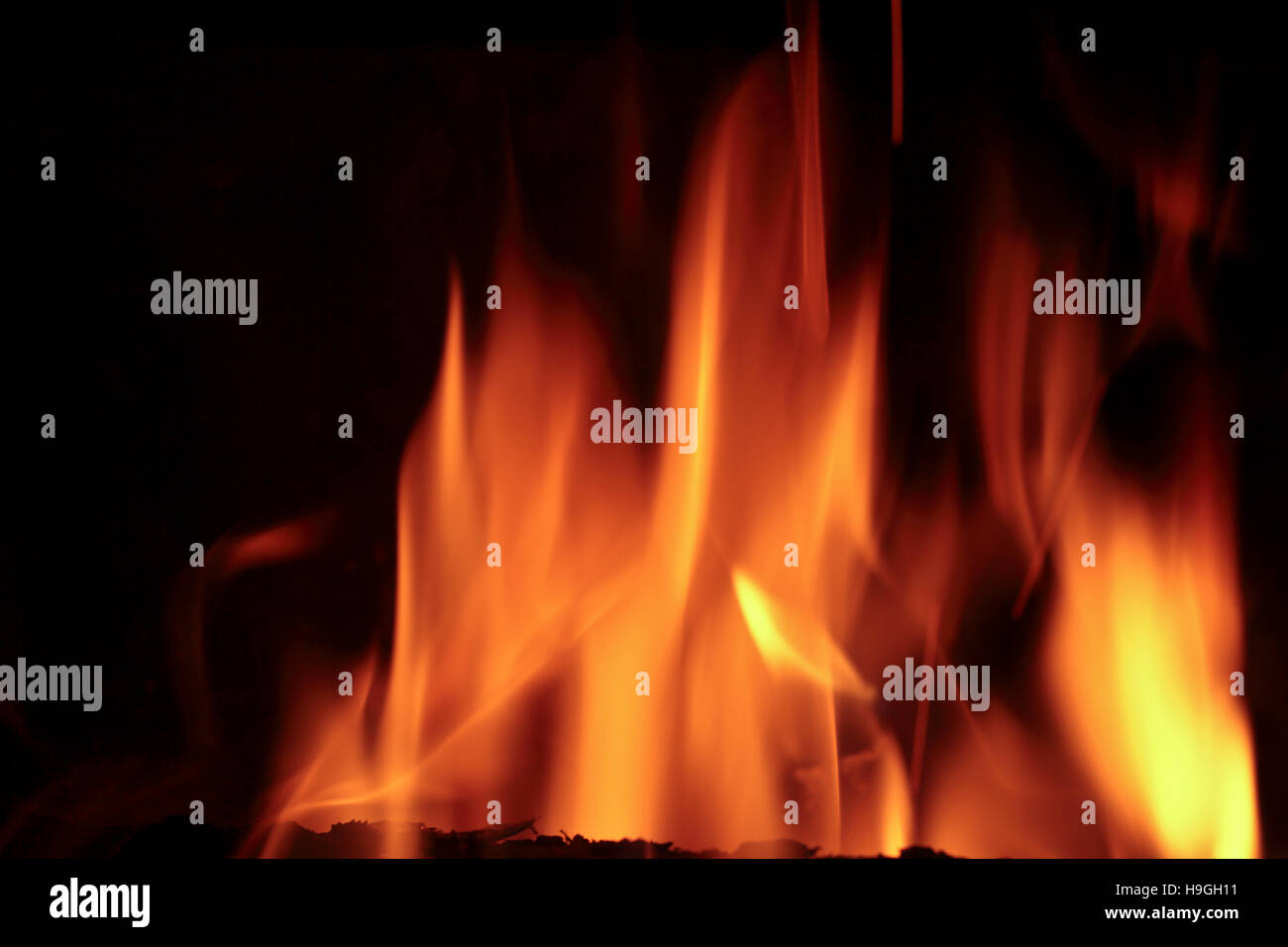 Flames of fire in a fireplace. Shooting horizontal with tones Orange ...