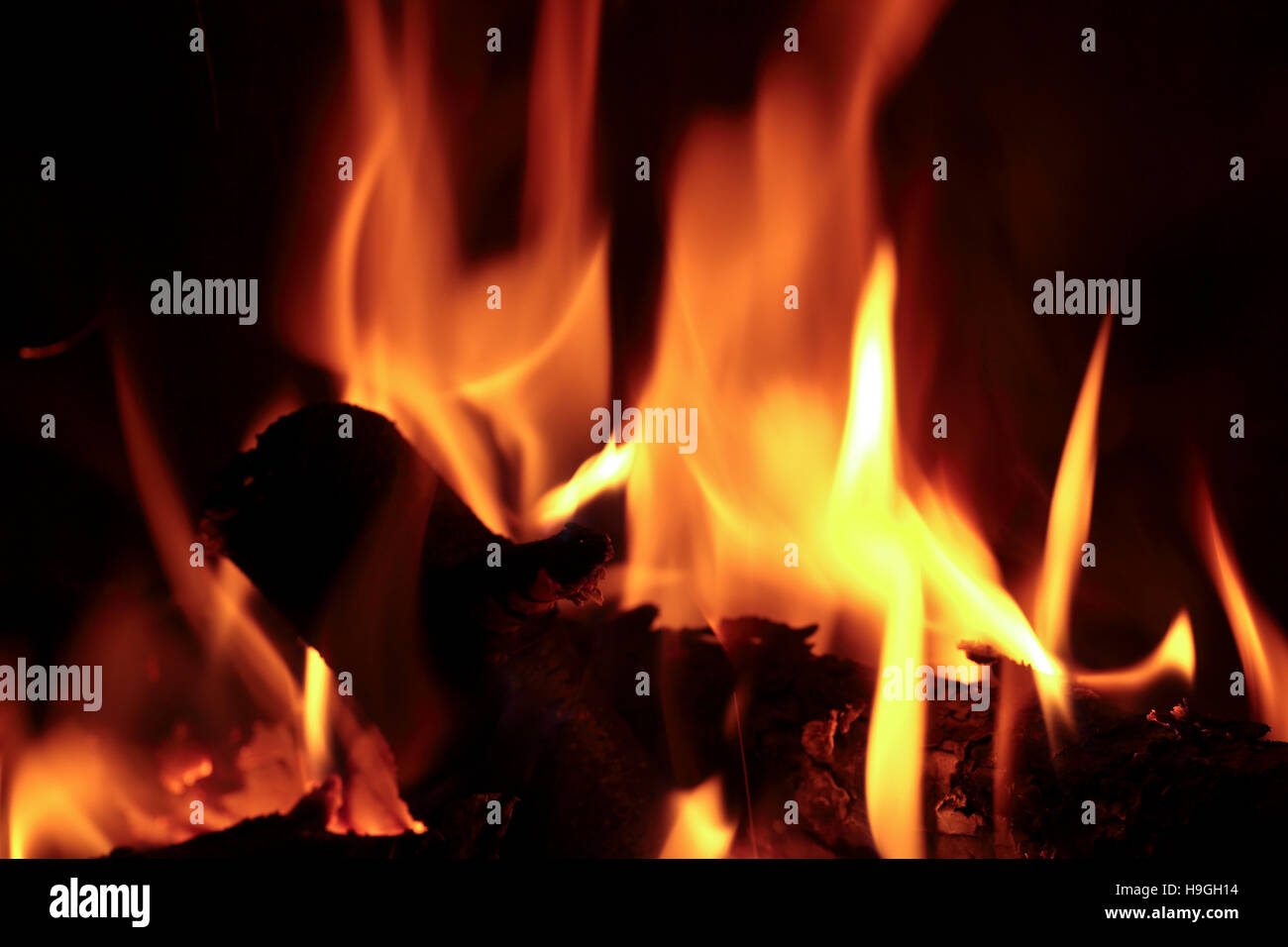 Flames of fire in a fireplace. Shooting horizontal with tones Orange ...