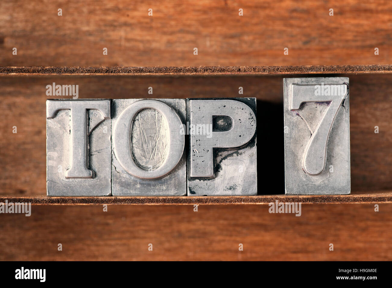 top 7 phrase made from metallic letterpress type on wooden tray Stock ...