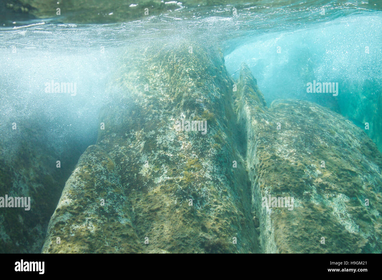 Underwater image of waves, crashed in the seashore rocks Stock Photo ...
