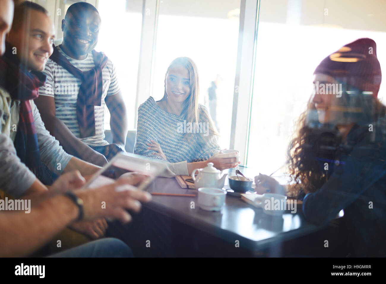 Adolescent friends having talk in cafe Stock Photo - Alamy