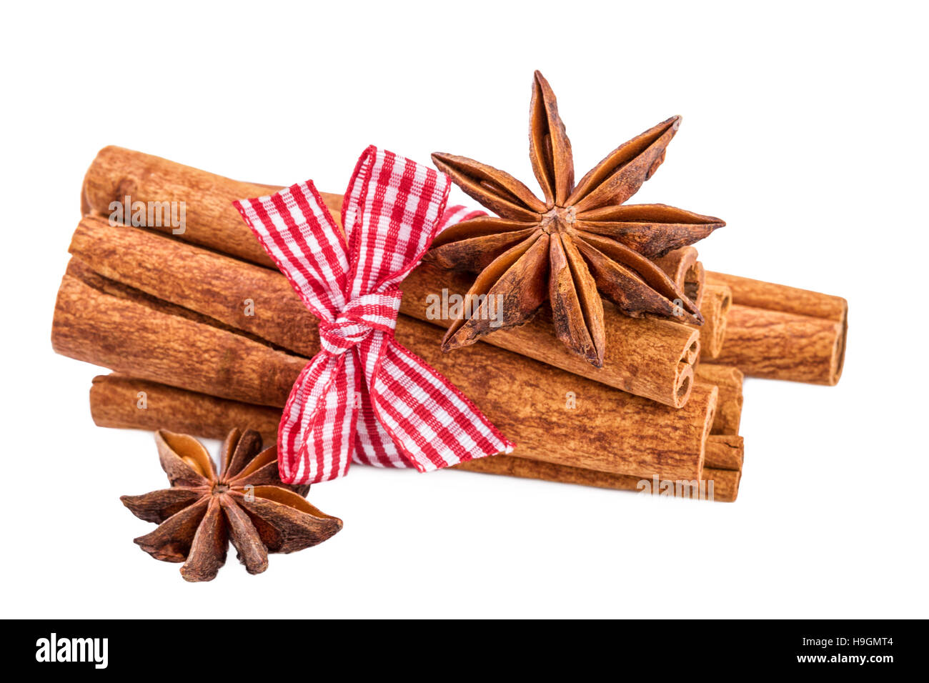 Cinnamon sticks bundle and anise over white.Traditional Christmas ...