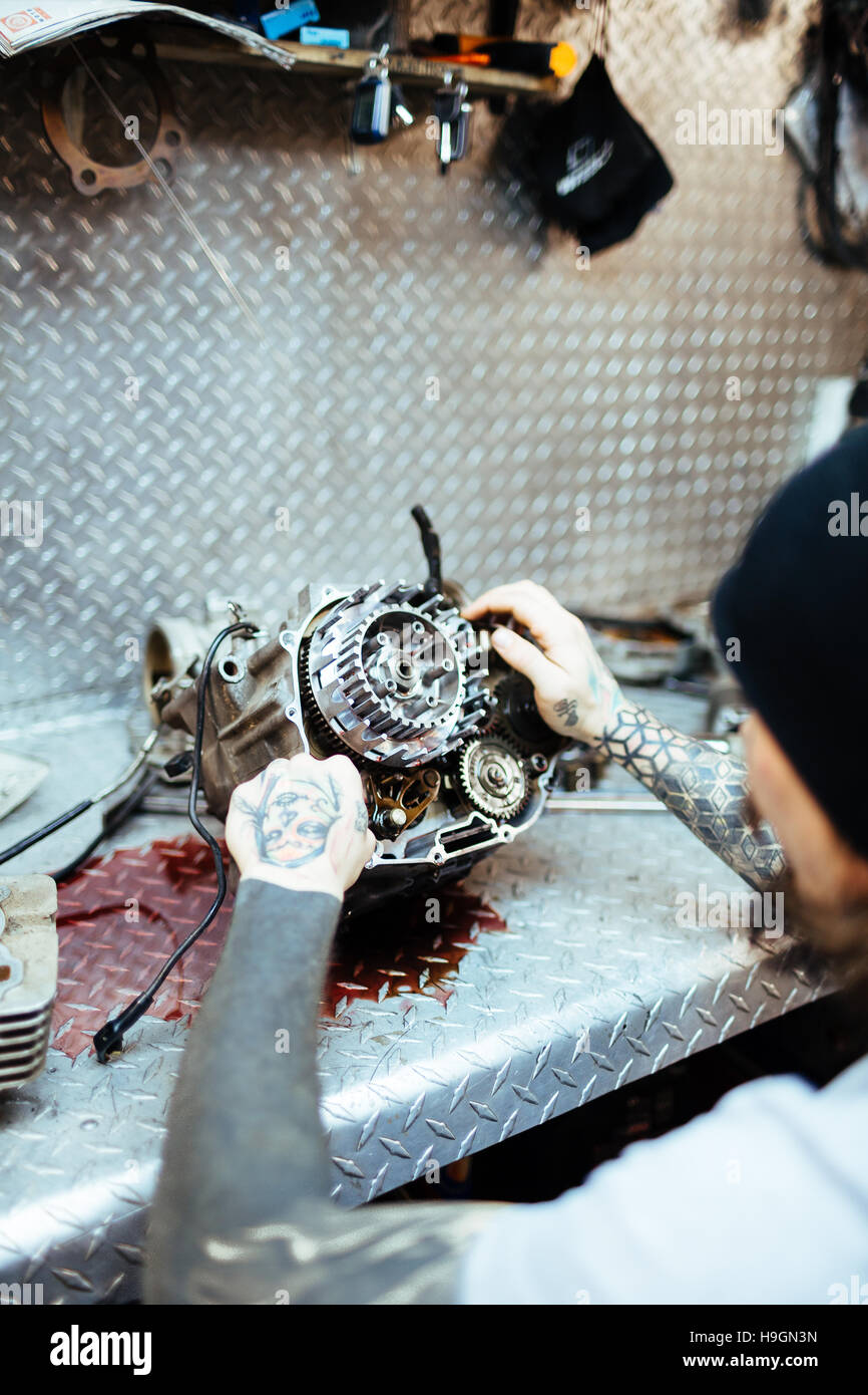 Technician checking up engine of motorbike Stock Photo - Alamy