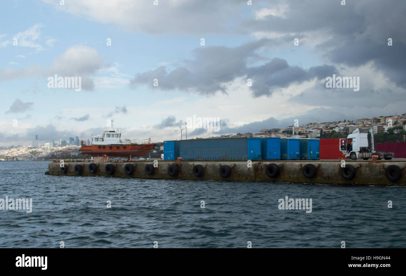 Seaport containers warehouse near sea and storm sky and old ship Stock ...