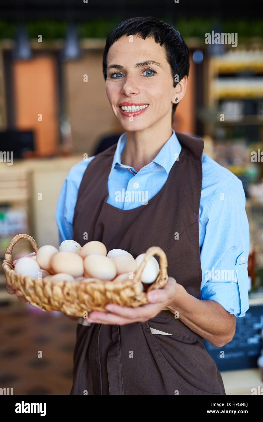 Grocery store owner holding basket with fresh eggs Stock Photo - Alamy
