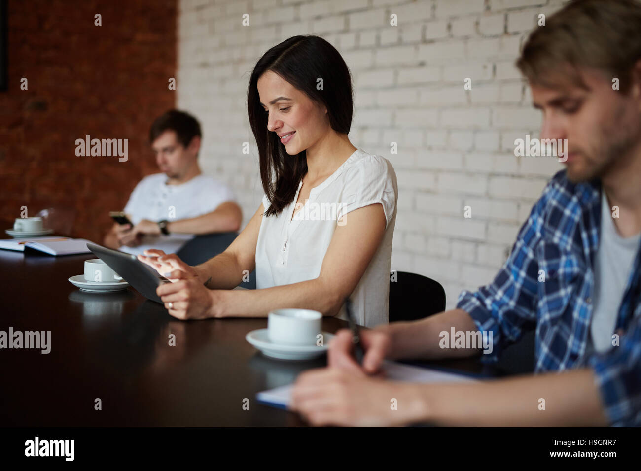 College students relaxing with gadgets at tea break Stock Photo - Alamy