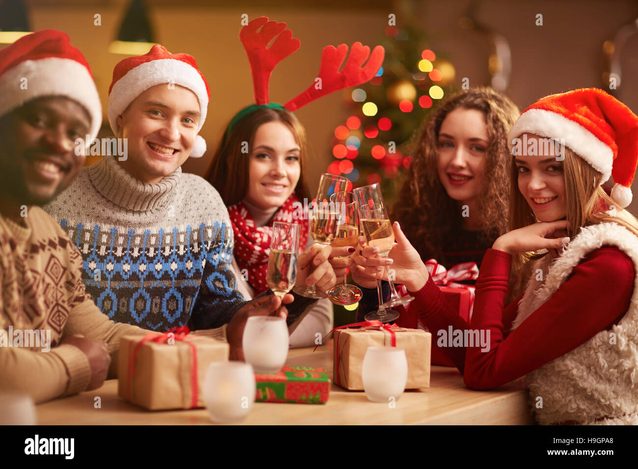 Cheerful friends celebrating Christmas together Stock Photo - Alamy