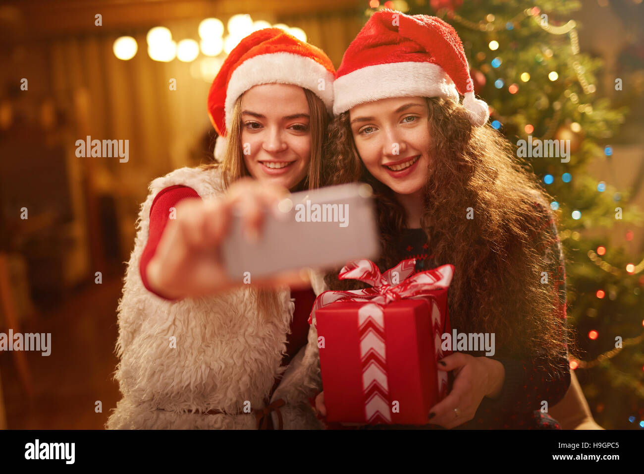 Girls making selfie during celebration of traditional winter holiday ...