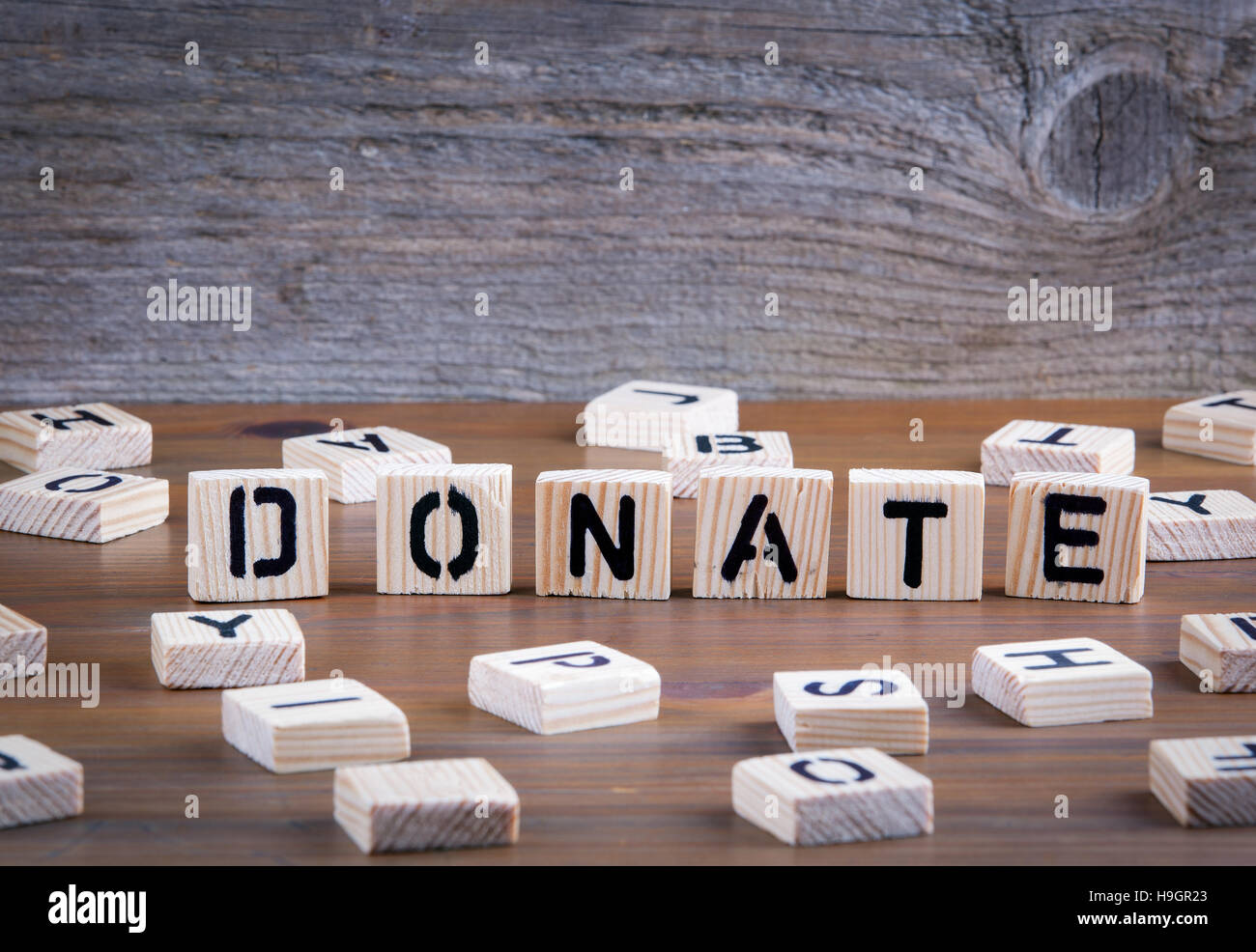 Donate from wooden letterson on wooden background Stock Photo - Alamy