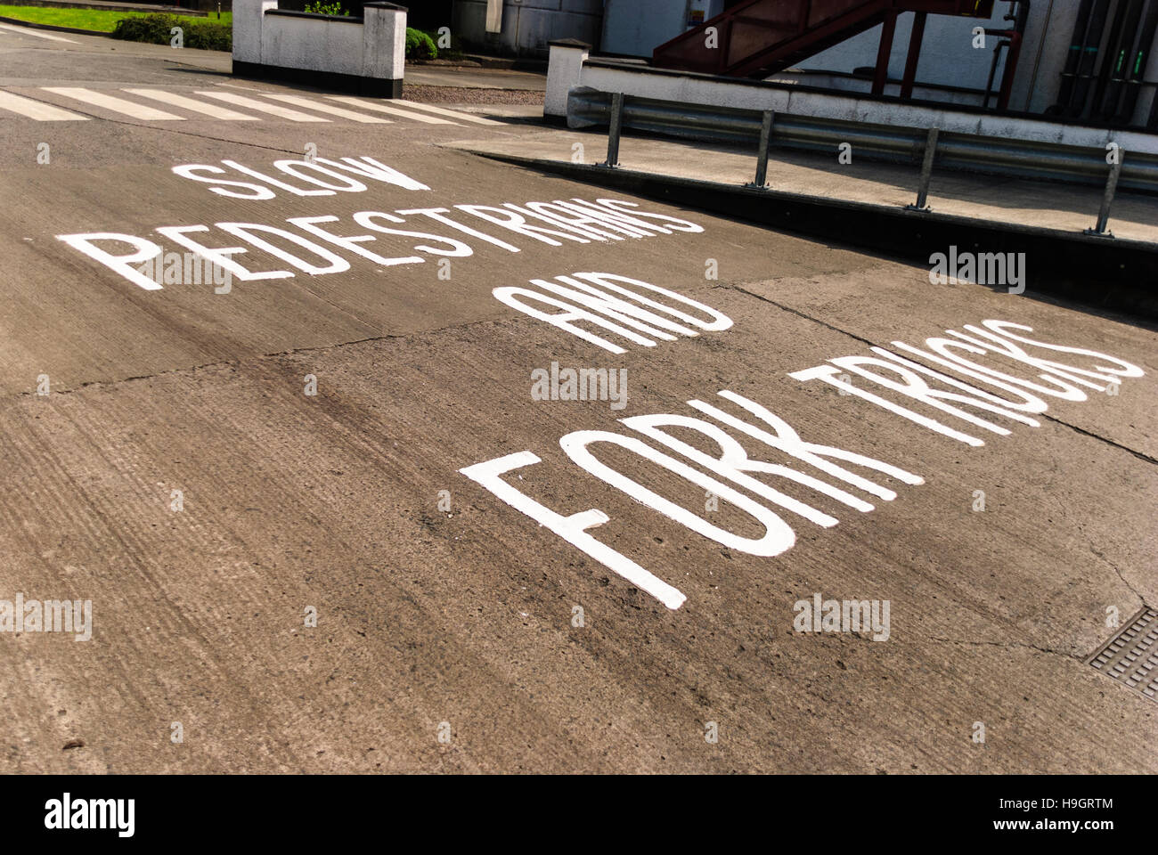 Road markings warning drivers to drive slow due to pedestrians and fork ...