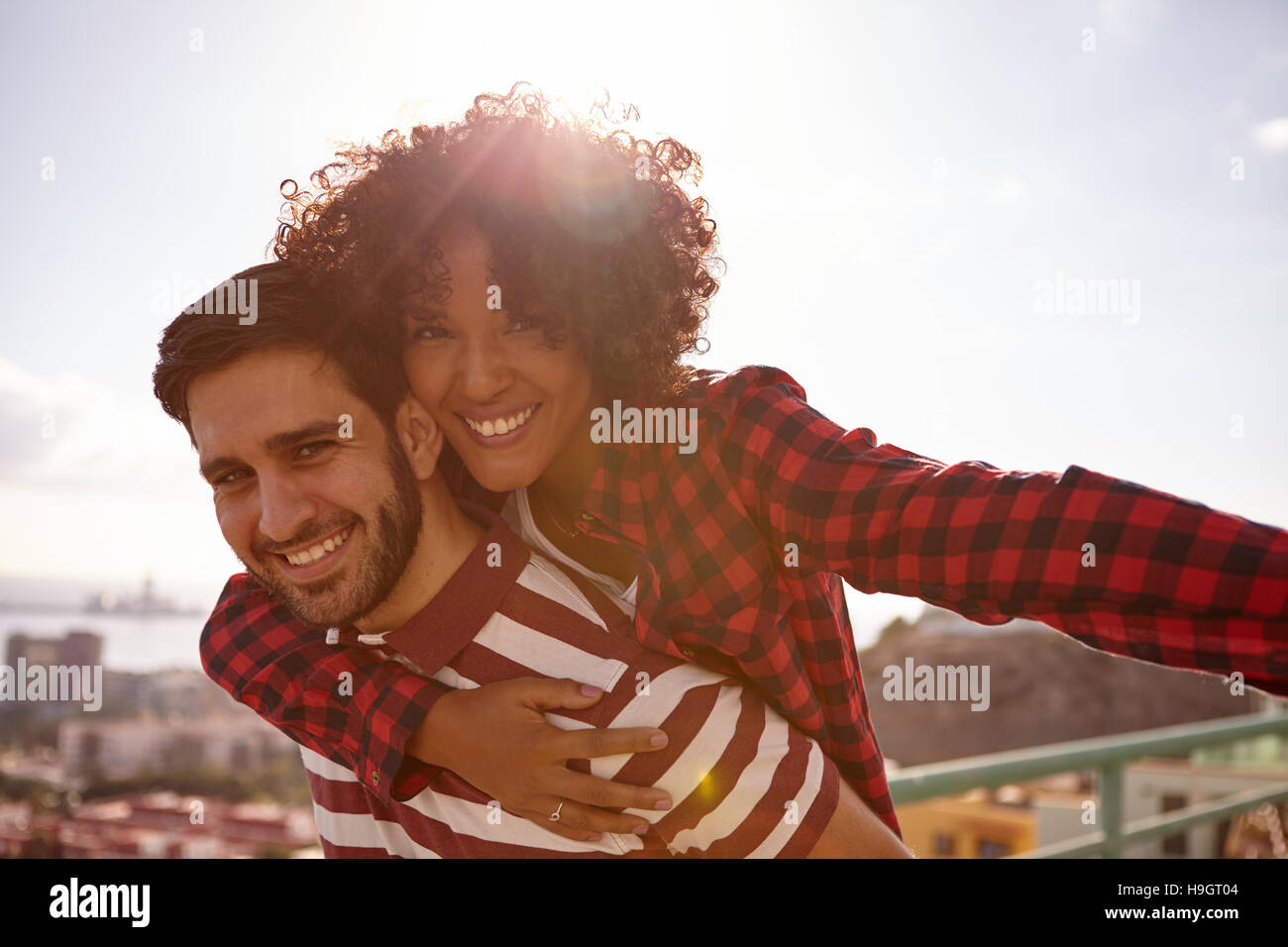 Loving couple gesturing aeroplane with her left arm out and holding ...