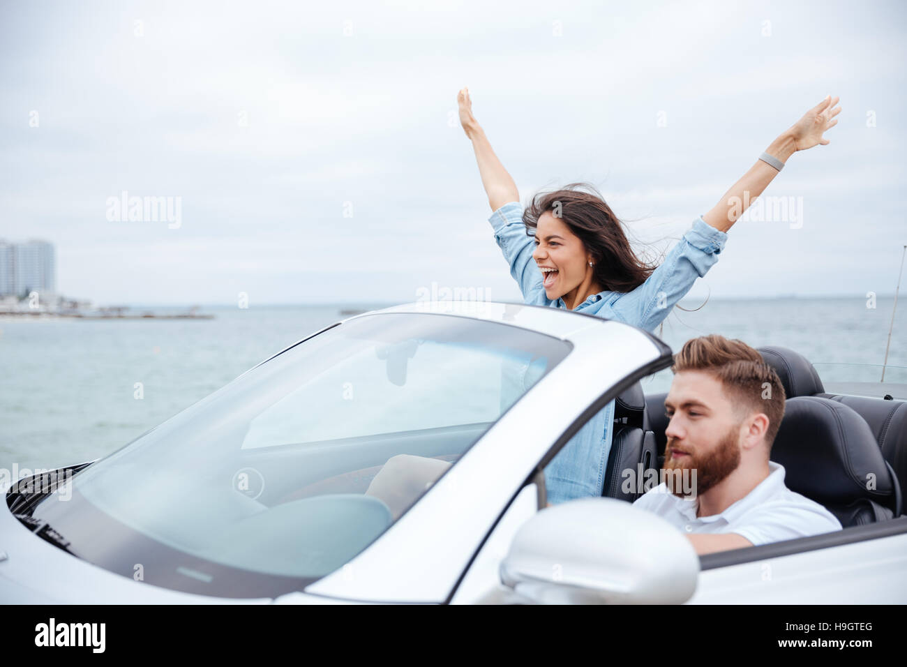 Young beautiful couple on road trip drive in car together Stock Photo ...