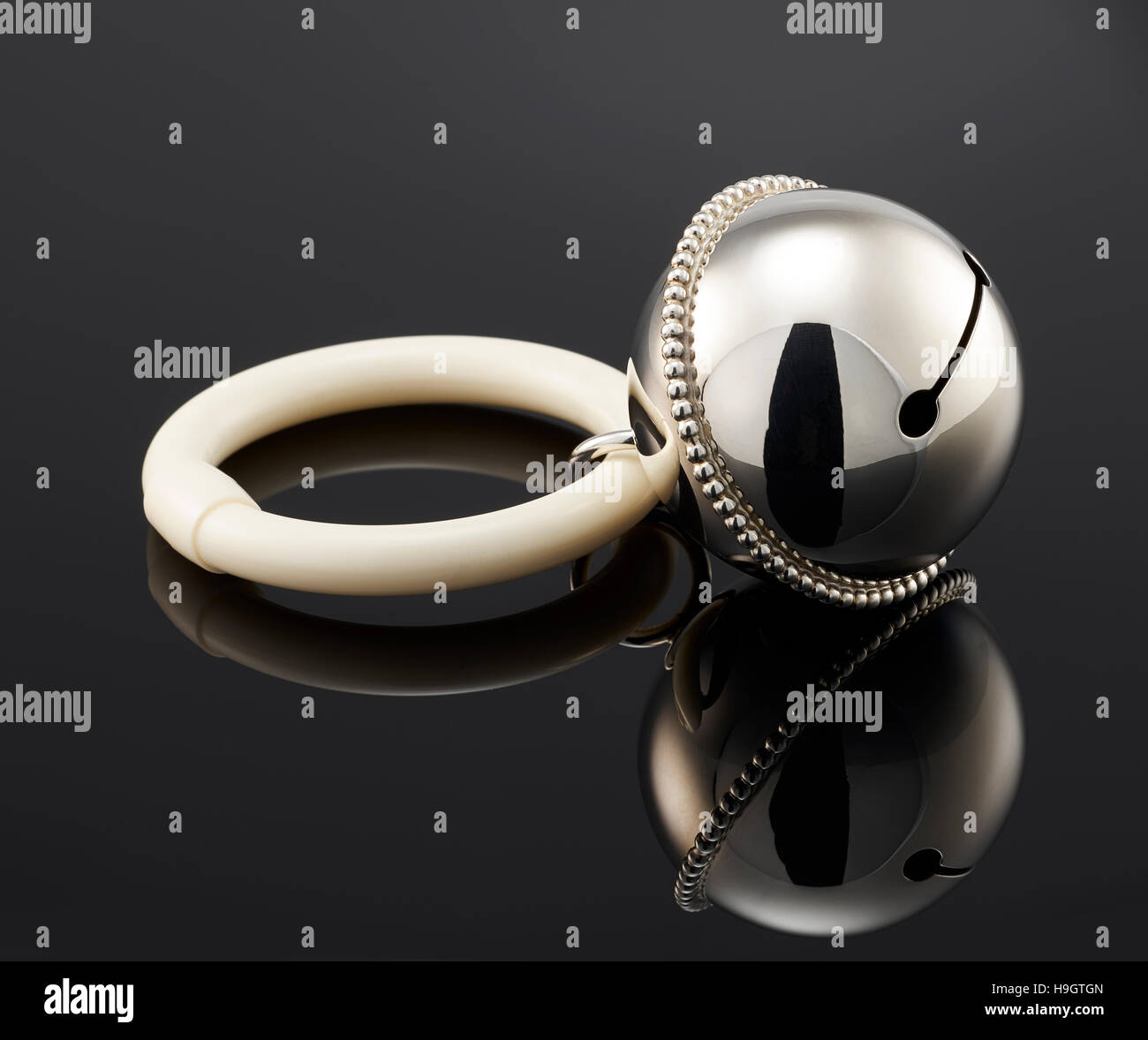 beautiful silver rattle toy on black background Stock Photo - Alamy