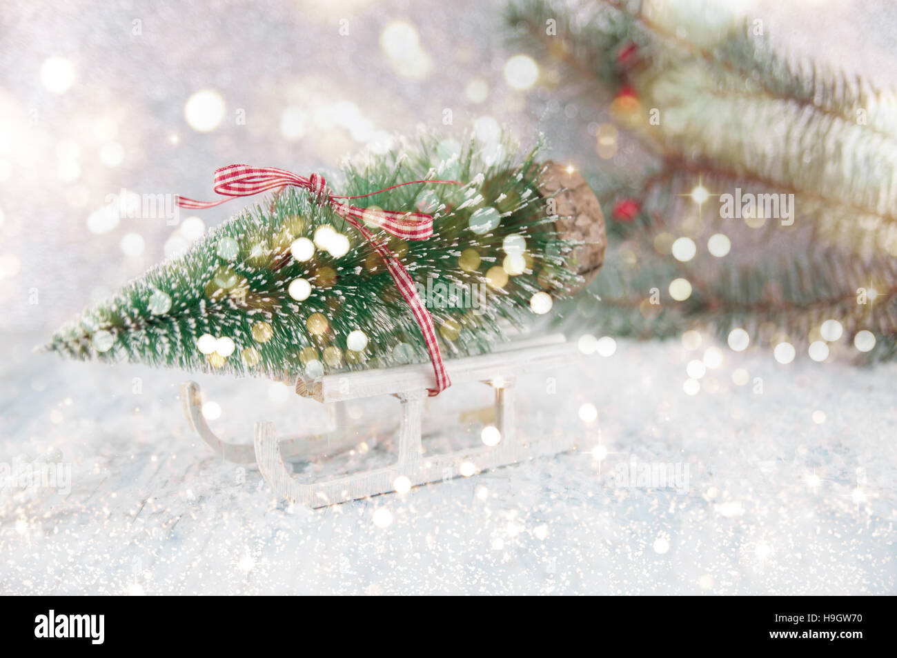 Small sleigh carrying a toy Christmas tree Stock Photo - Alamy