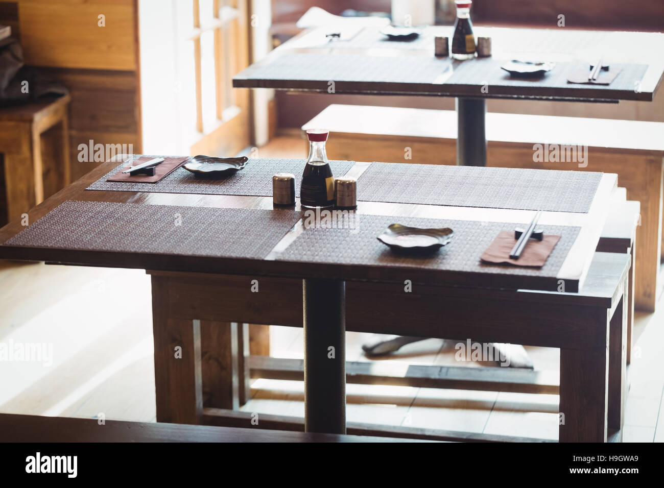 Empty dining tables and benches Stock Photo - Alamy