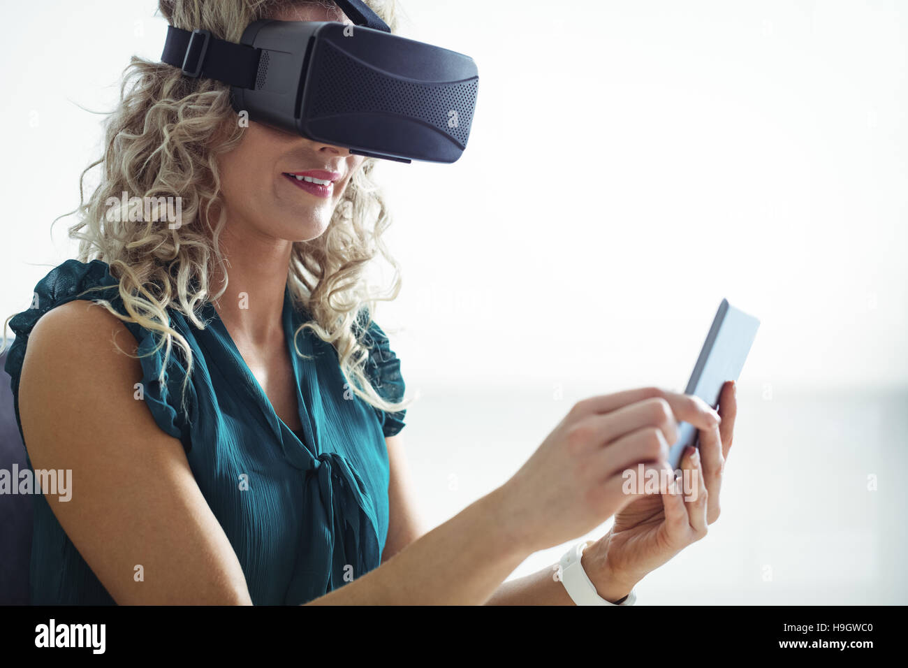 Business executive using virtual reality headset and digital tablet ...