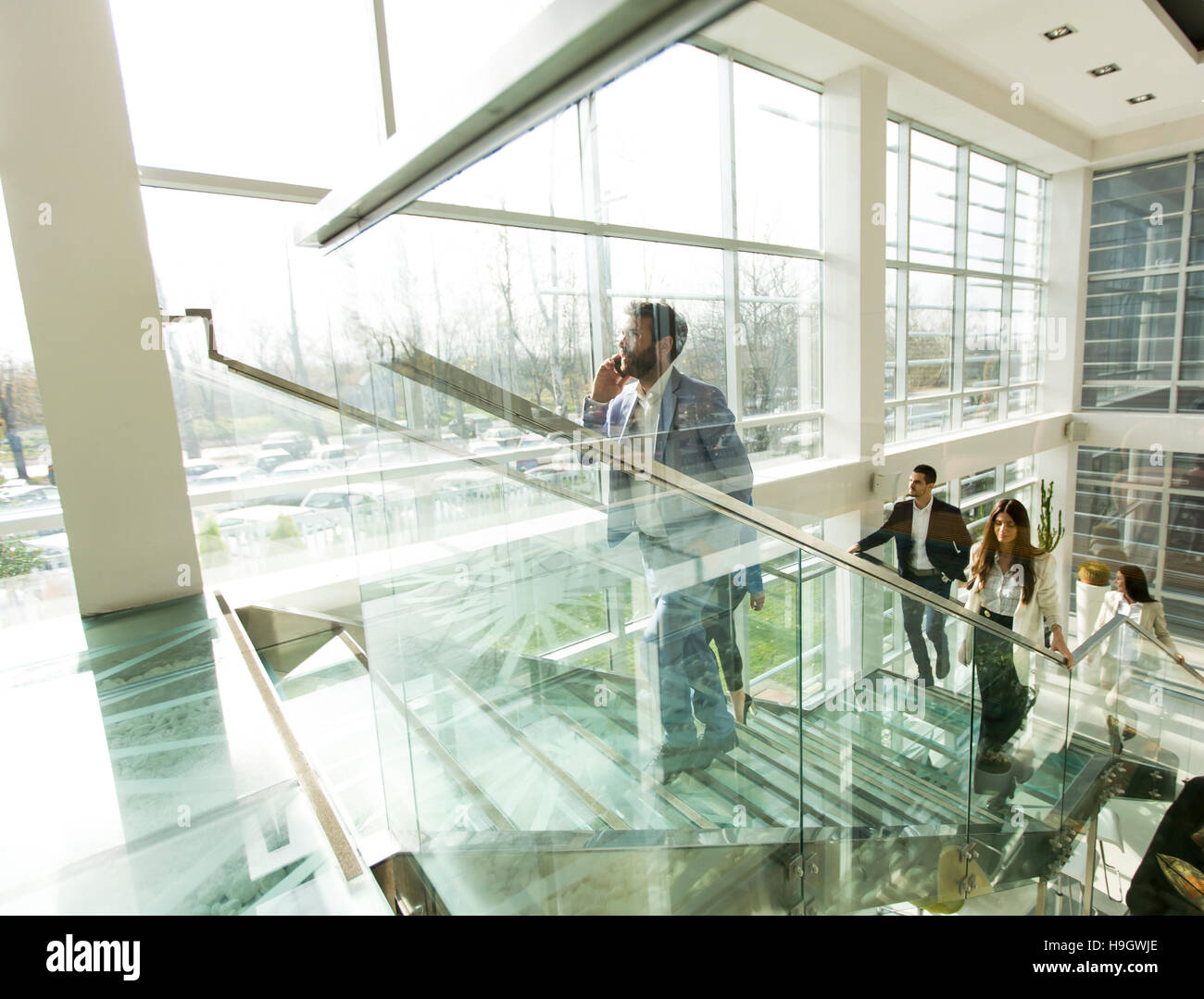 Young business people climb the stairs in the office building Stock ...