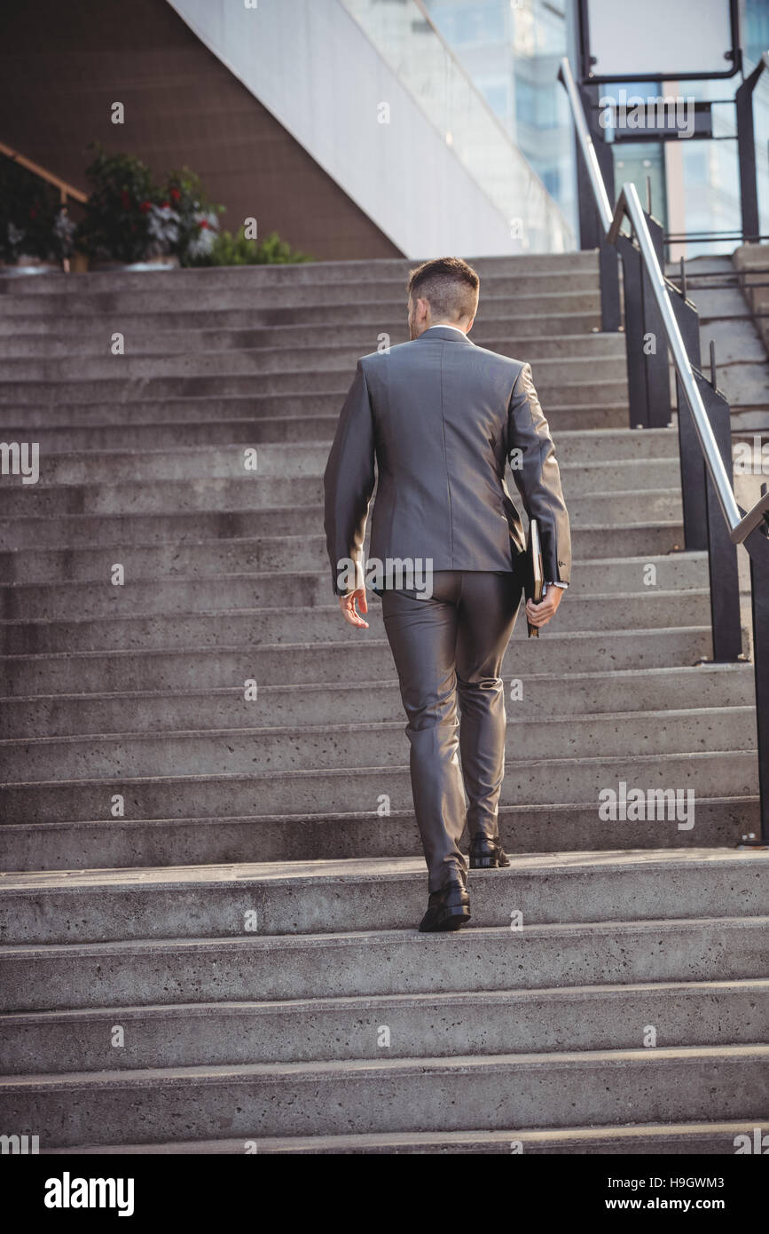 Man walking up stairs hi-res stock photography and images - Alamy