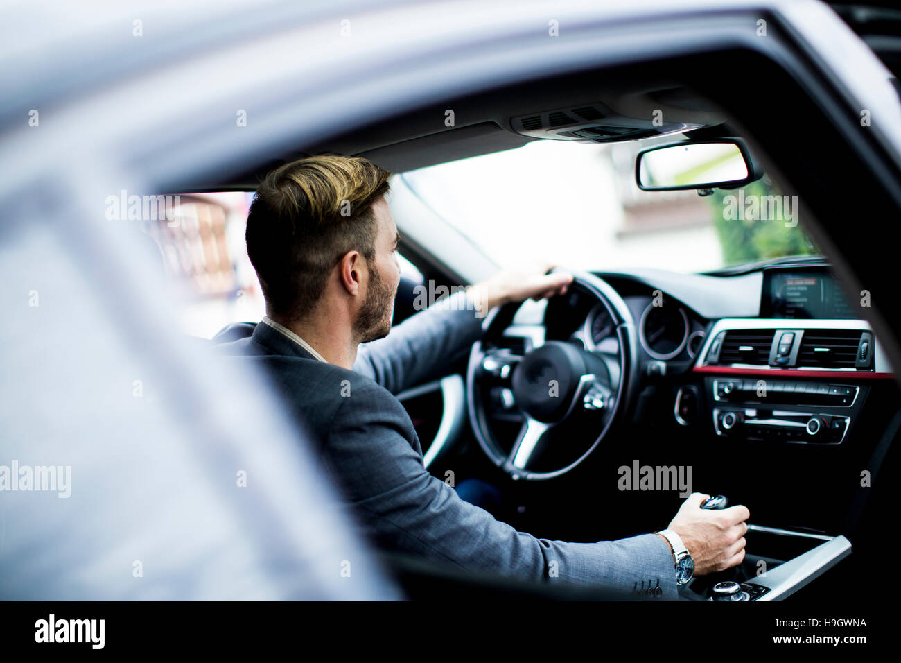 Young man driving in the modern car Stock Photo - Alamy
