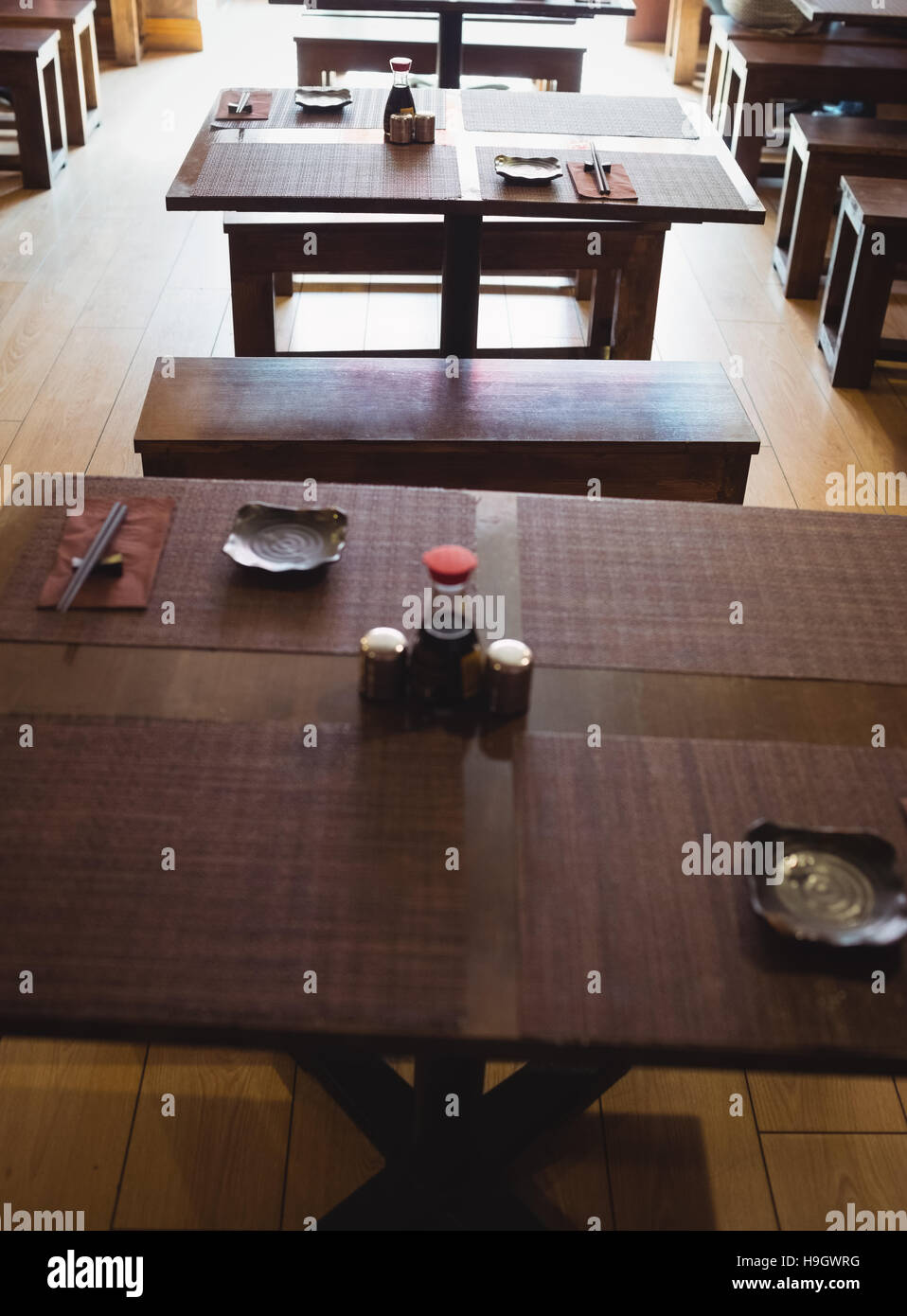 Empty dining tables and benches Stock Photo - Alamy
