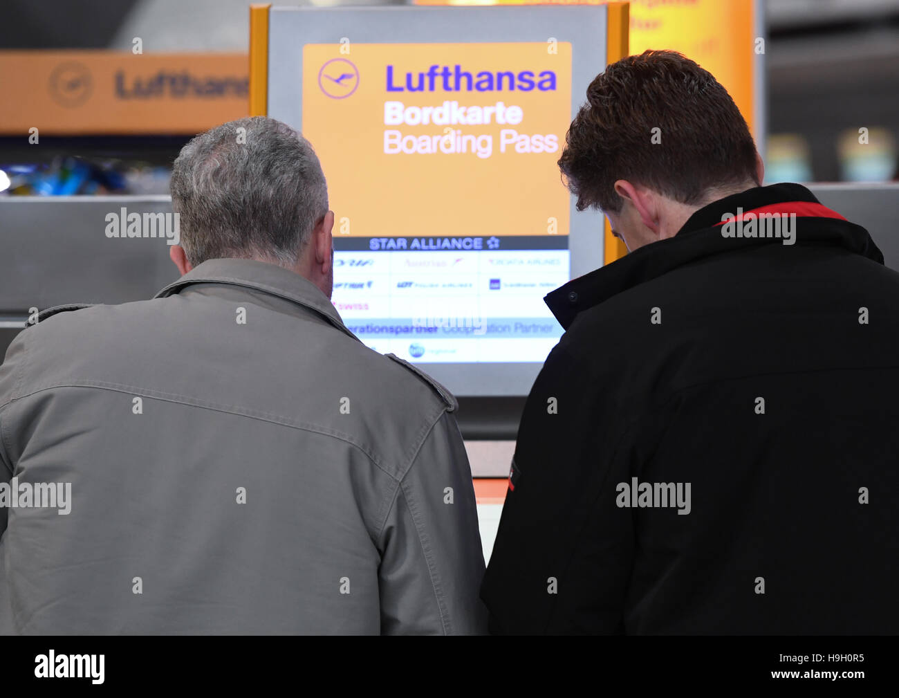 Travellers at a Lufthansa check-in machine in Terminal 1 of the airport ...