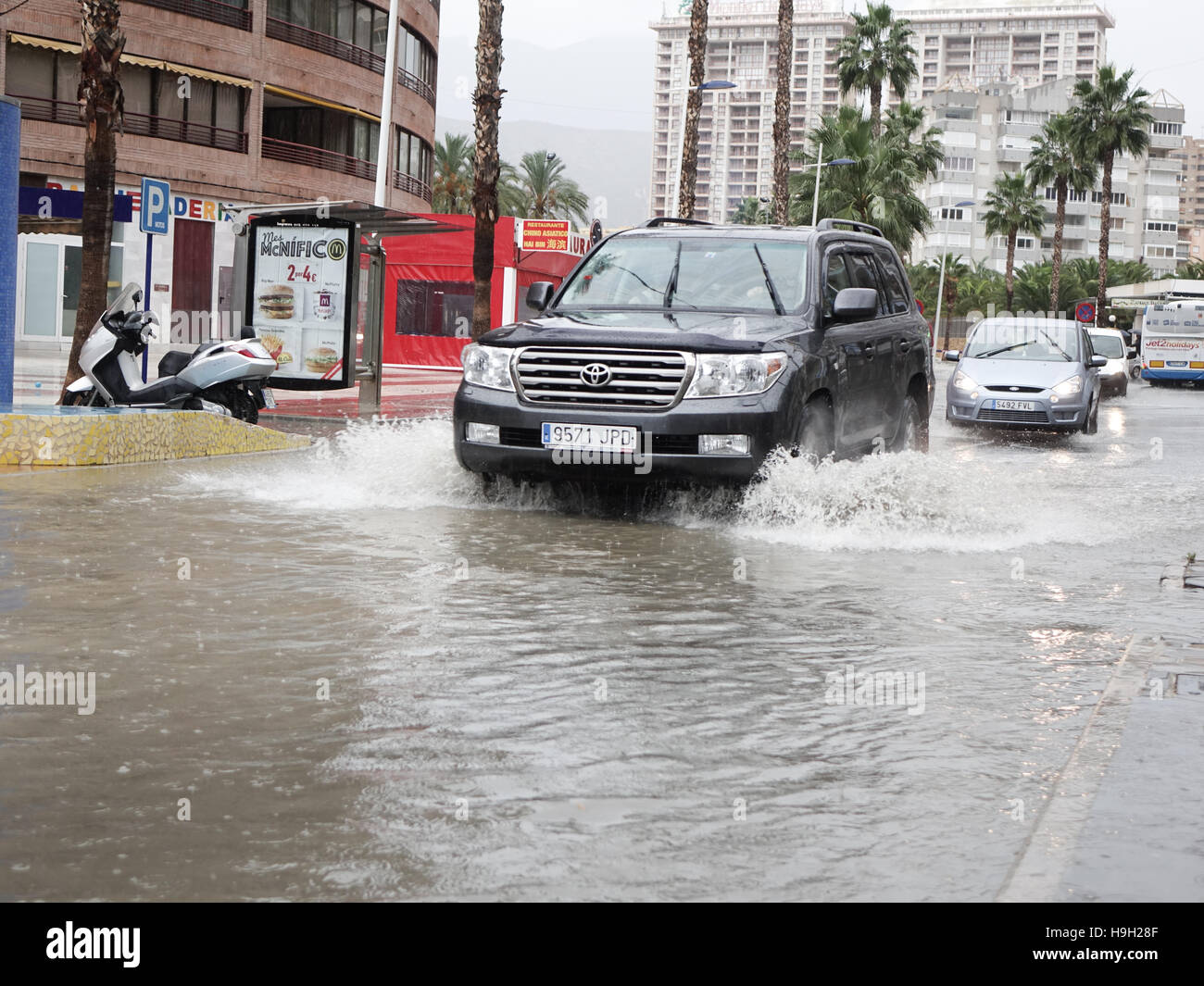 Vehicles drive through flooded streets in La Cala, Benidorm, Alicante ...