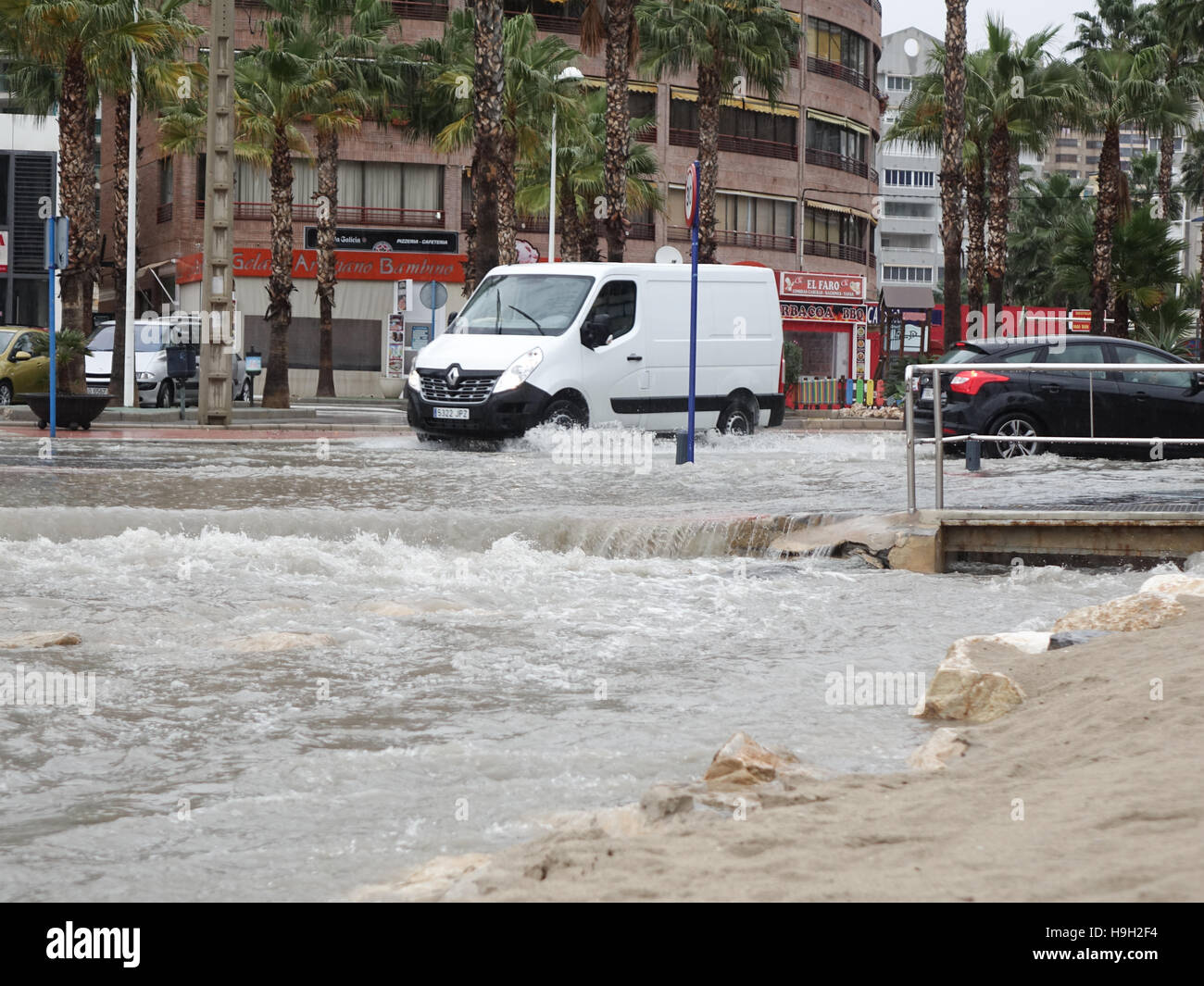 Vehicles drive through flooded streets in La Cala, Benidorm, Alicante ...