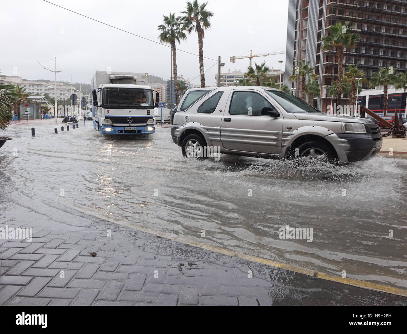 Vehicles drive through flooded streets in La Cala, Benidorm, Alicante ...