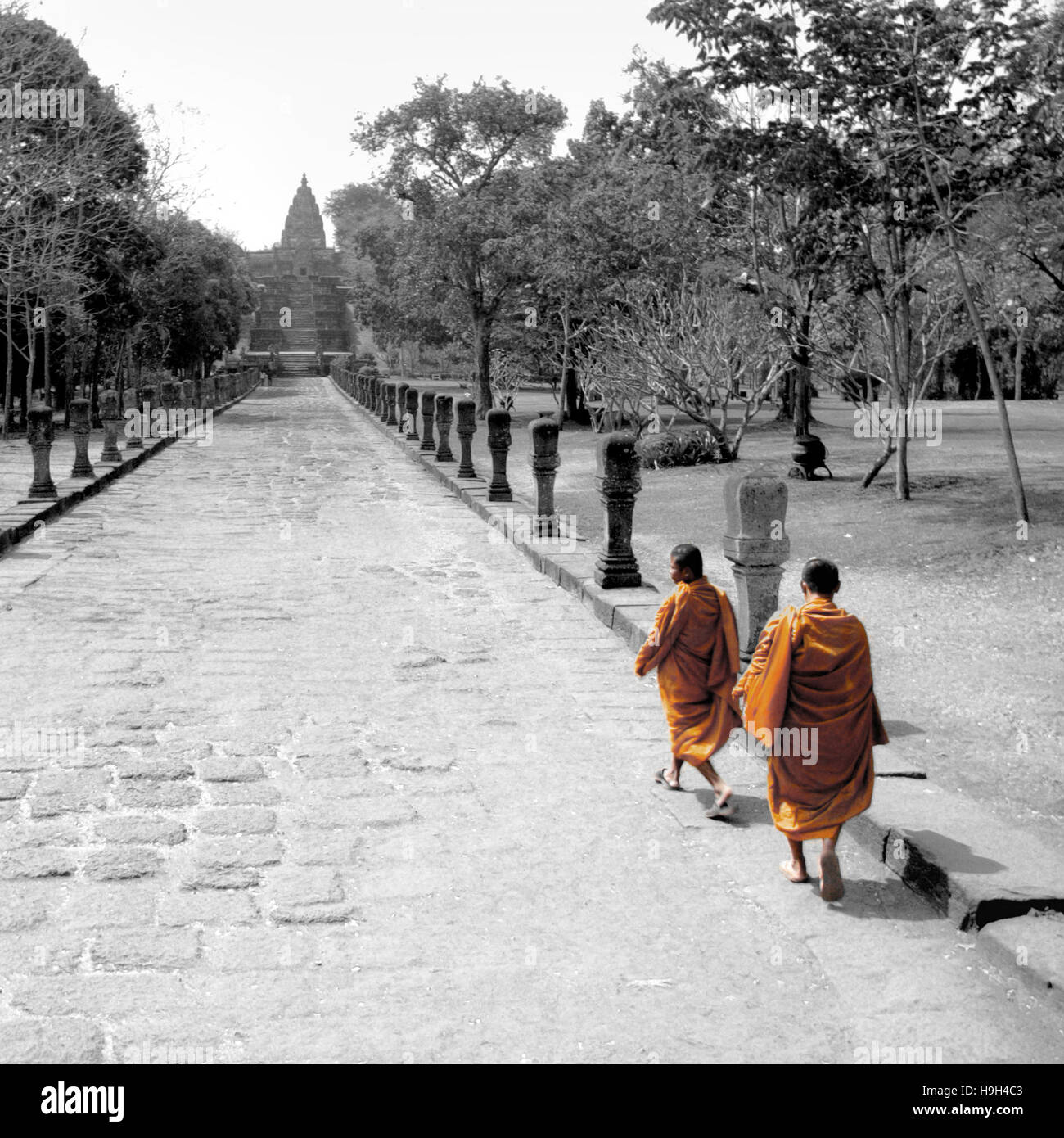 2 Monks walk towards Phanom Rung temple complex buddhist temple in ...