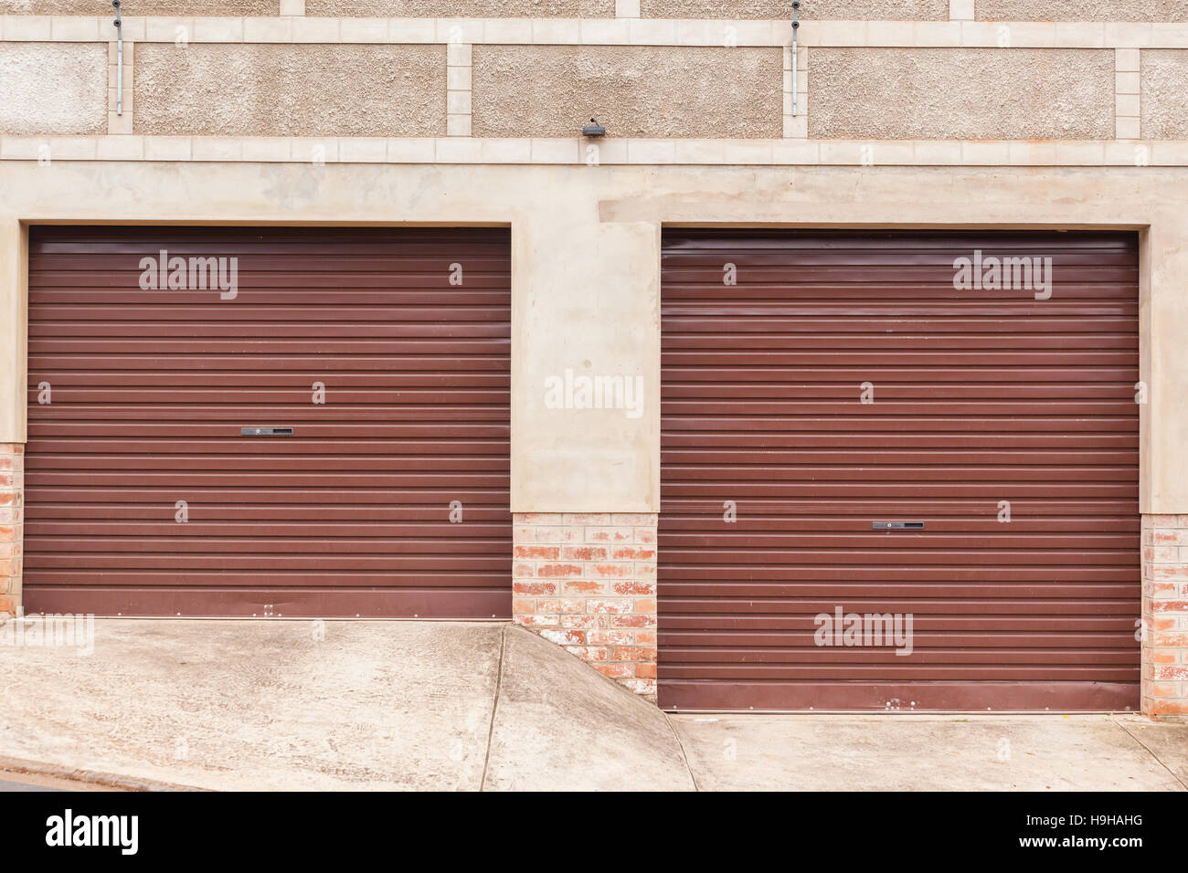 Garage building two metal roll up doors for vehicles outside roadside ...