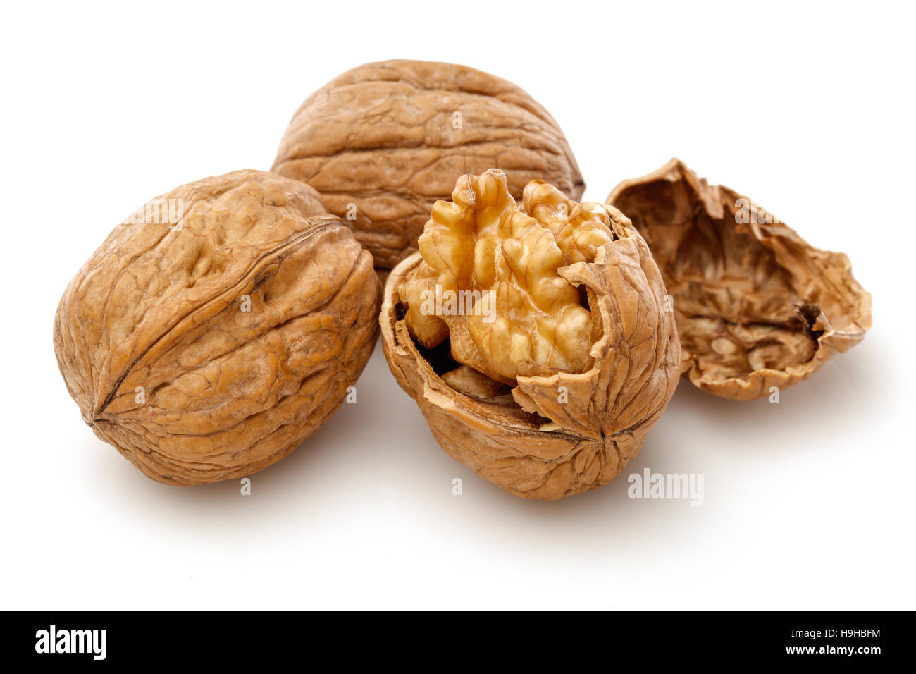 Broken walnut kernel and whole walnut. Isolated on a white background ...