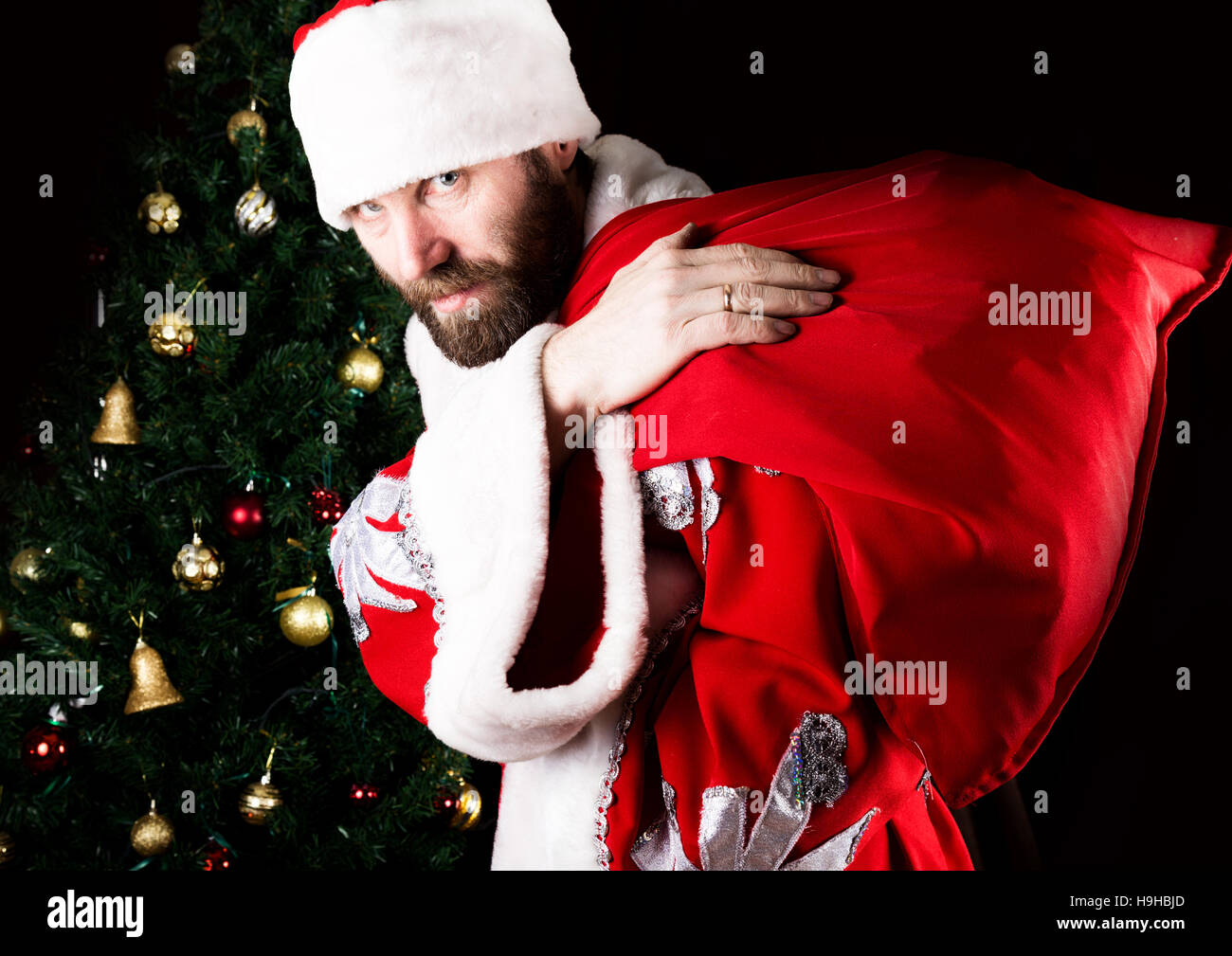 bad brutal Santa Claus carries a bag and smiling spitefully, on the ...