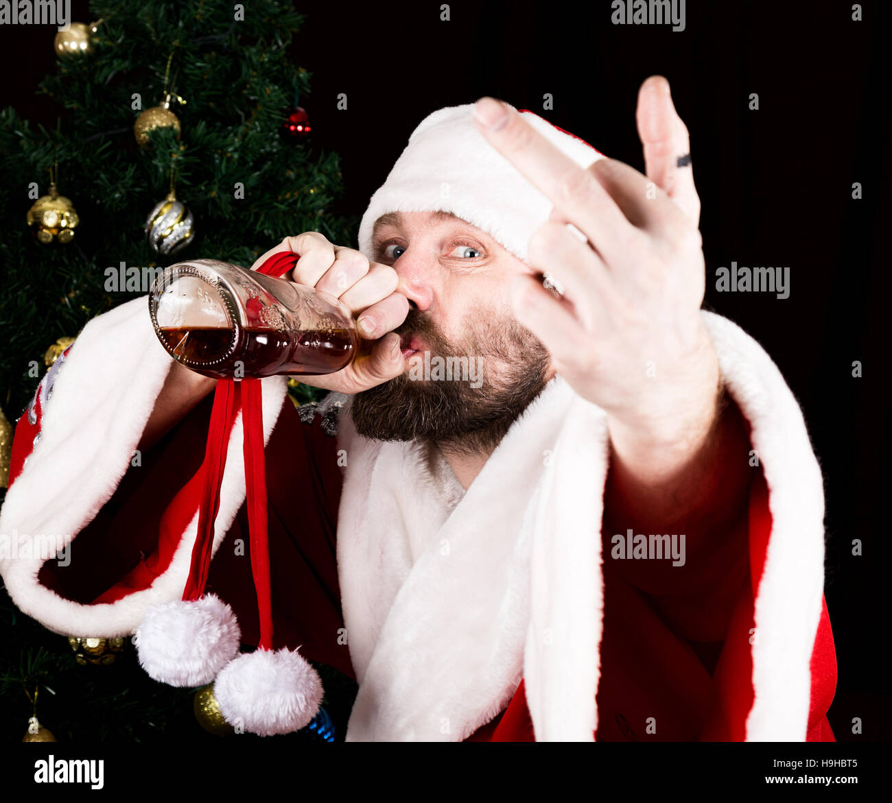 bad brutal Santa Claus smiling spitefully, drinking brandy from a ...