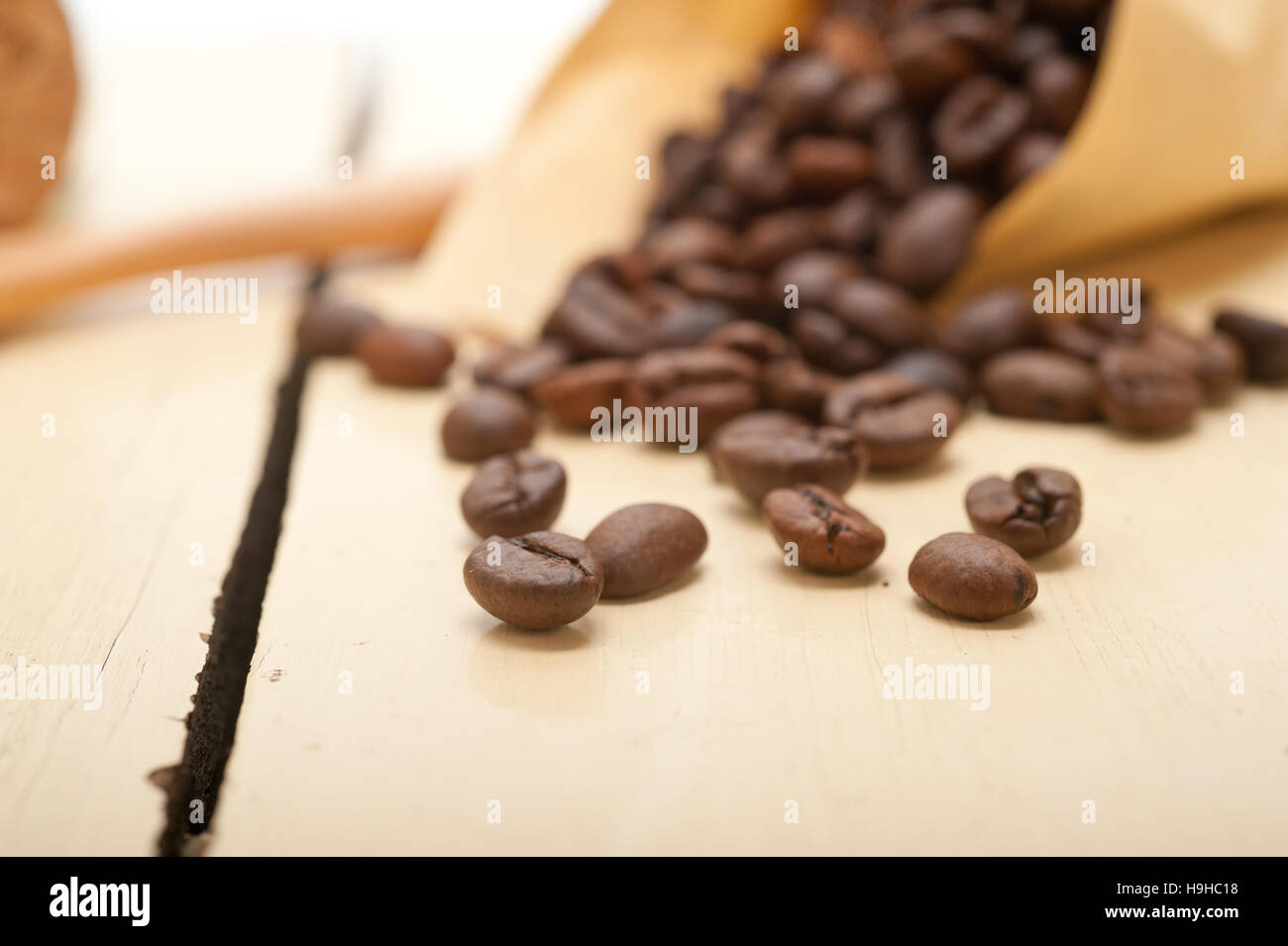 espresso coffee beans on a paper cone cornucopia over white background ...