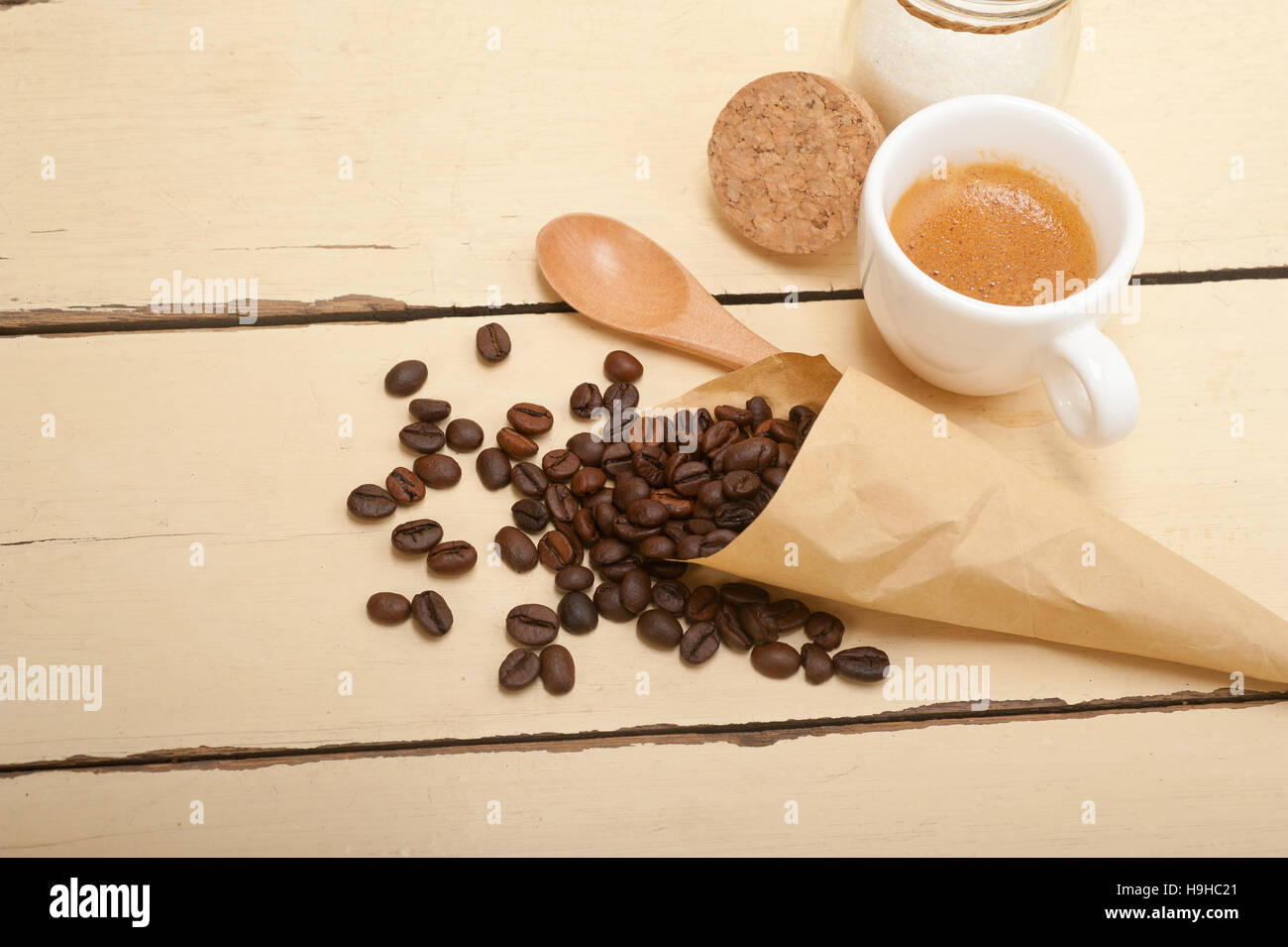 espresso coffee and beans on a paper cone cornucopia over white ...