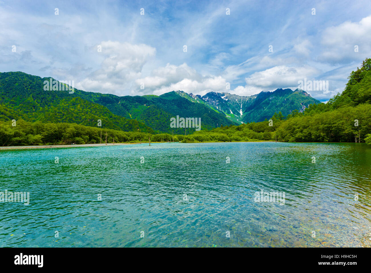 Landscape of turquoise water of Taisho Pond shoreline with nature view ...