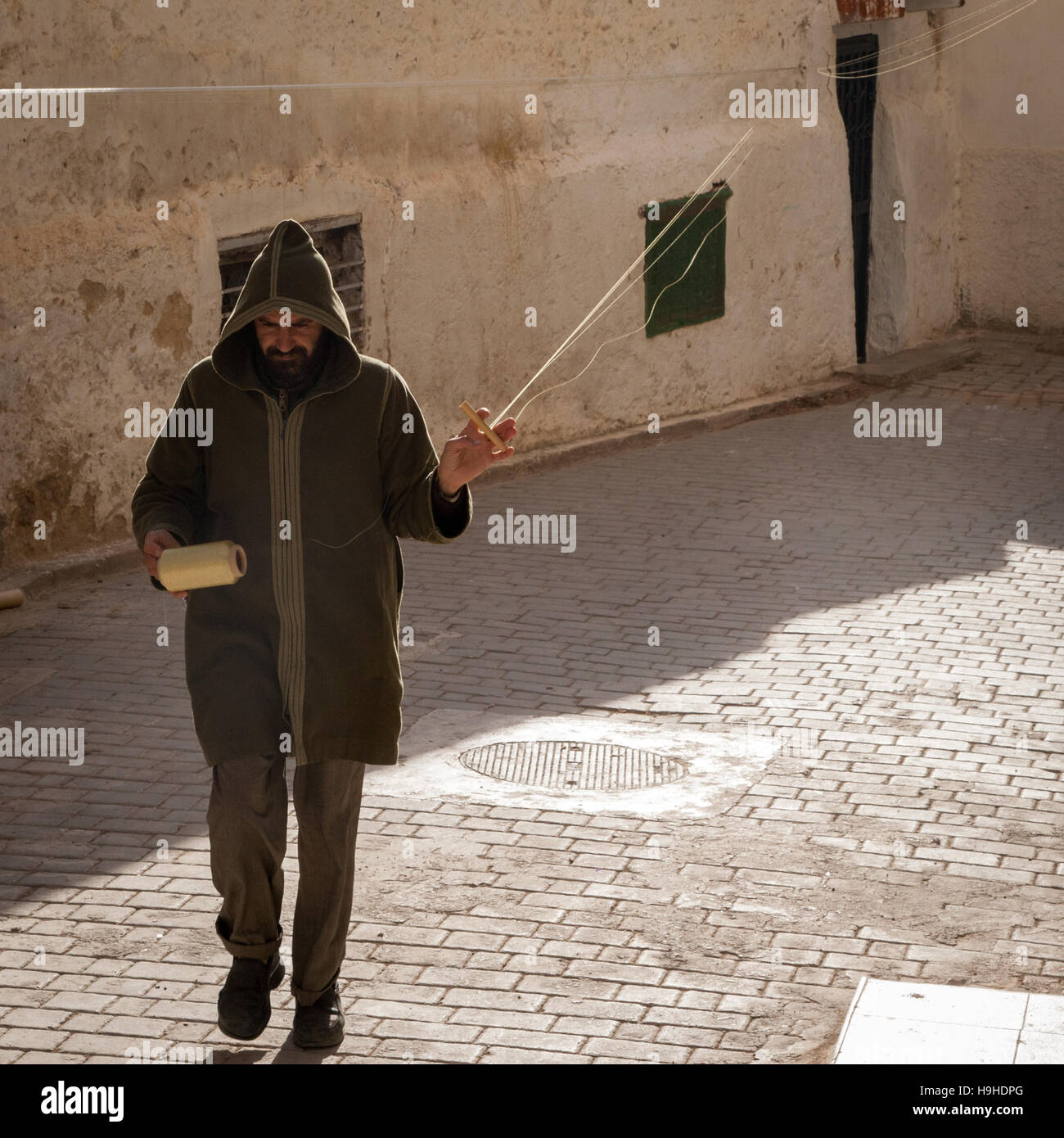 Craftsman stretching yarn in street to spin it afterwards Stock Photo ...