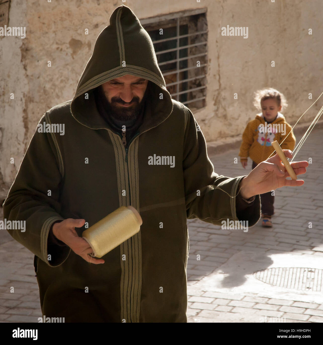 Craftsman stretching yarn in street to spin it afterwards Stock Photo ...
