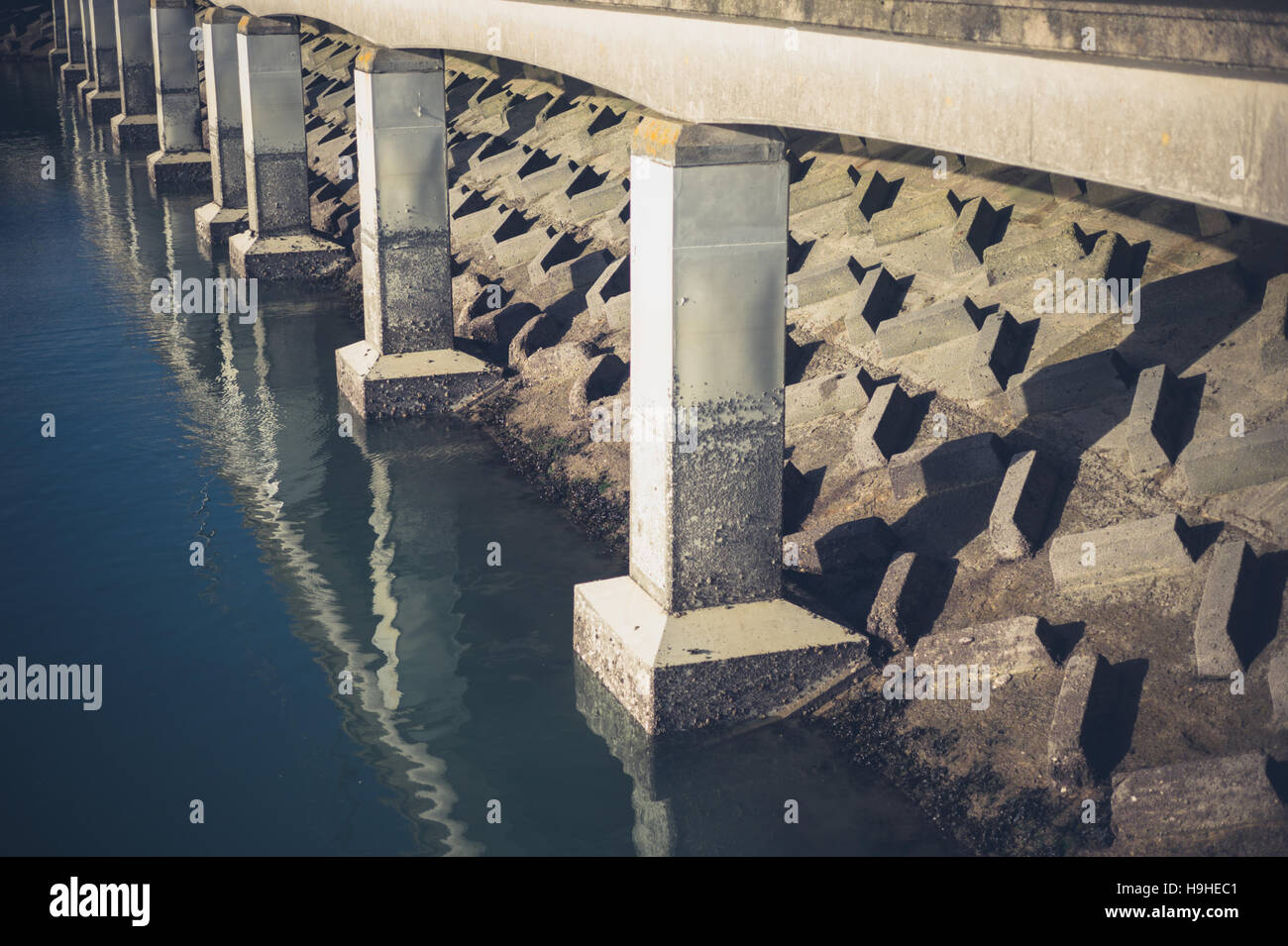 Concreete pillars supporting a bridge by the sea Stock Photo - Alamy